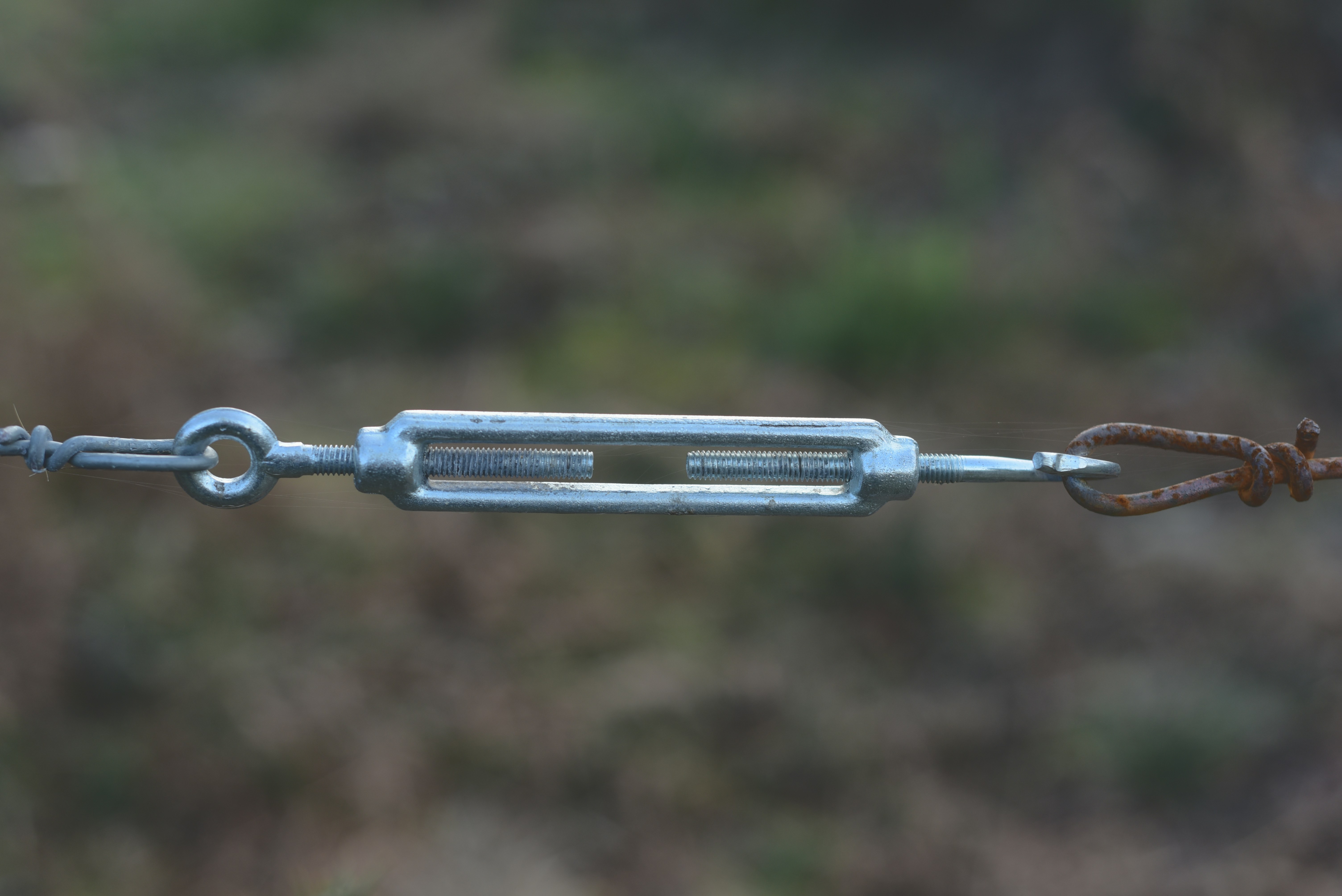 Tension Point: Close-Up of a Galvanized Wire Clamp