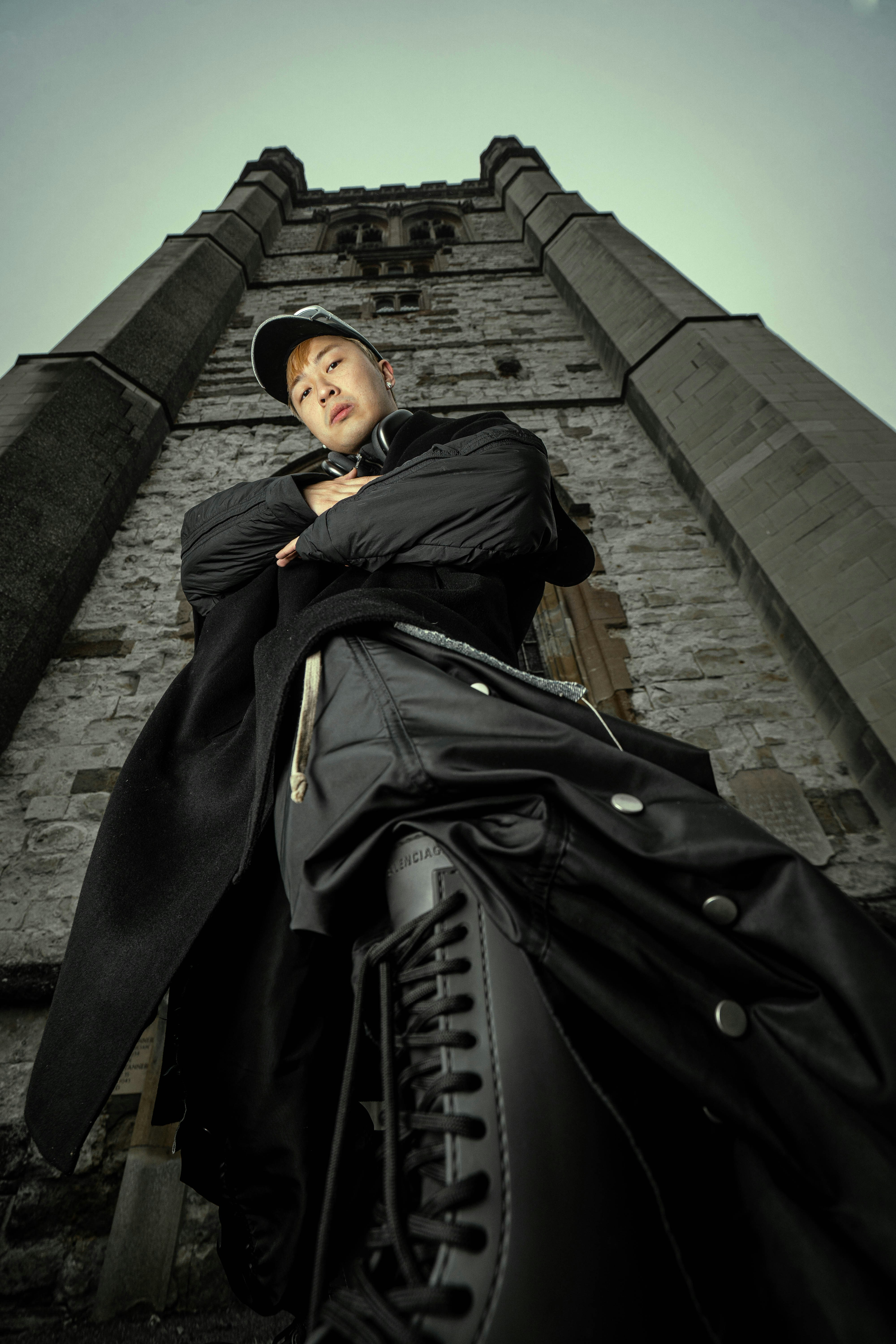 Low-Angle Portrait at the Gate: A Moment Beneath Stone Giants