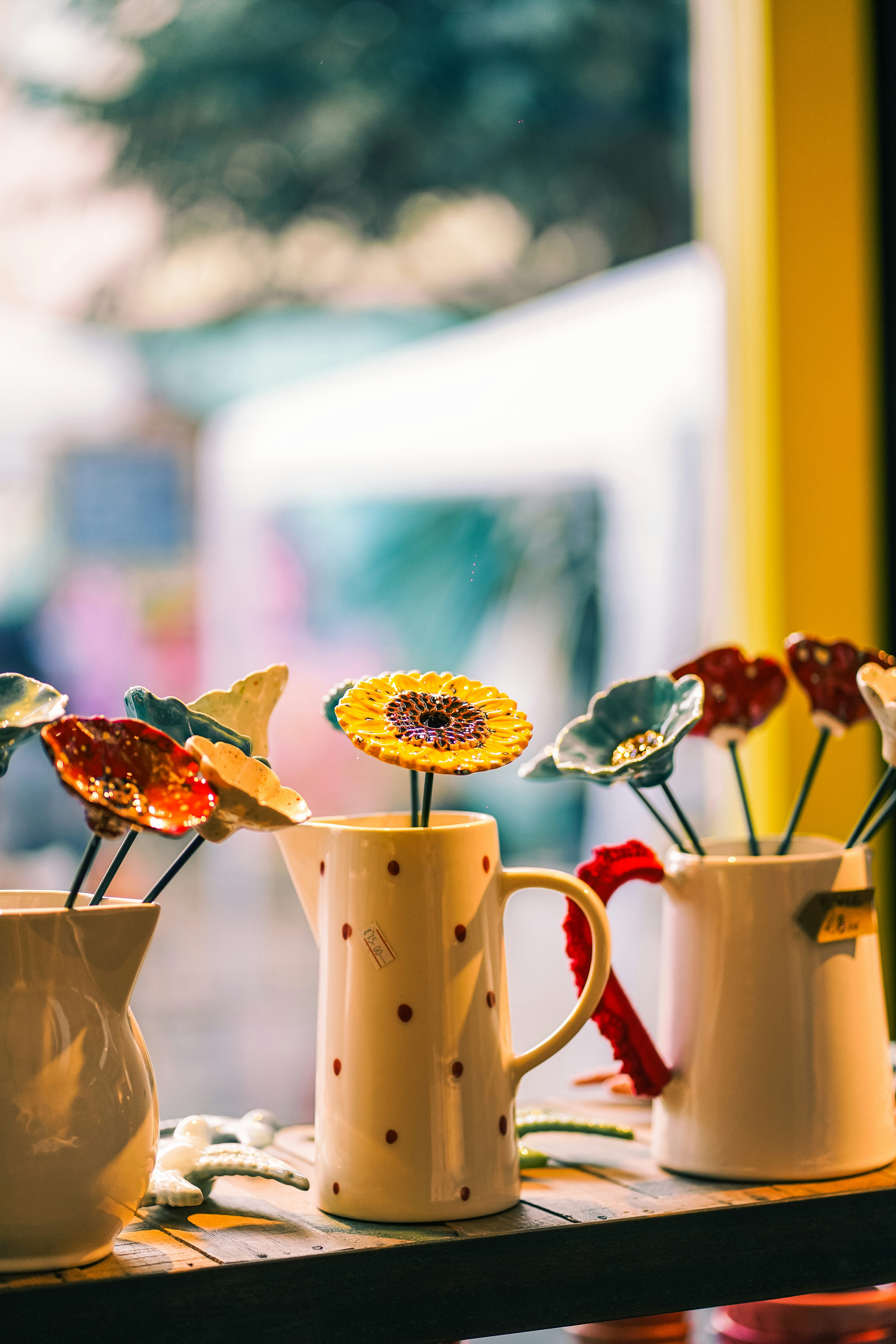 Sunny Ceramics: A Row of Polka-Dot Mugs with Bright Floral Stems