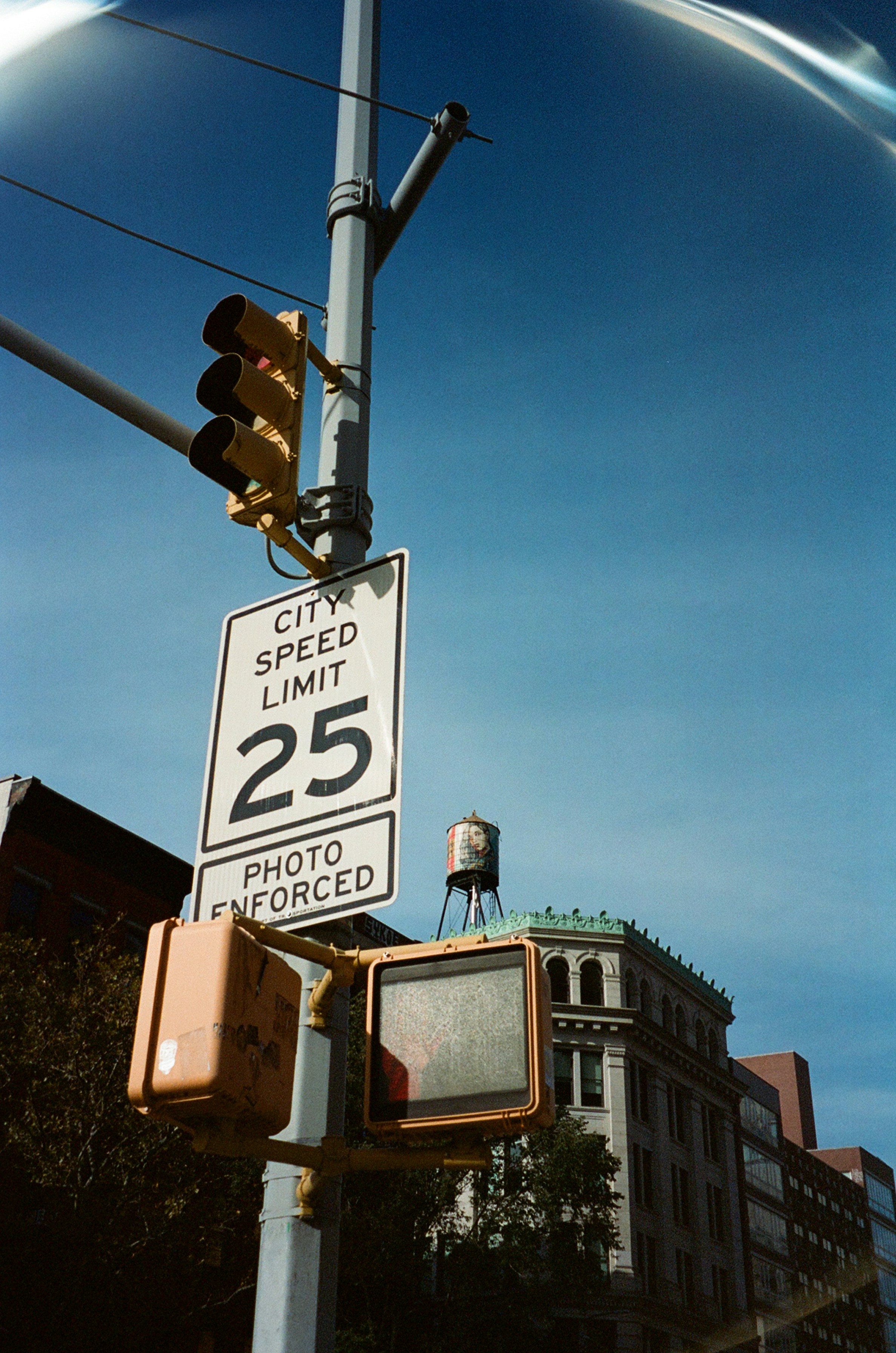 A traffic light with a speed limit sign on it photo – Free Manhattan ...