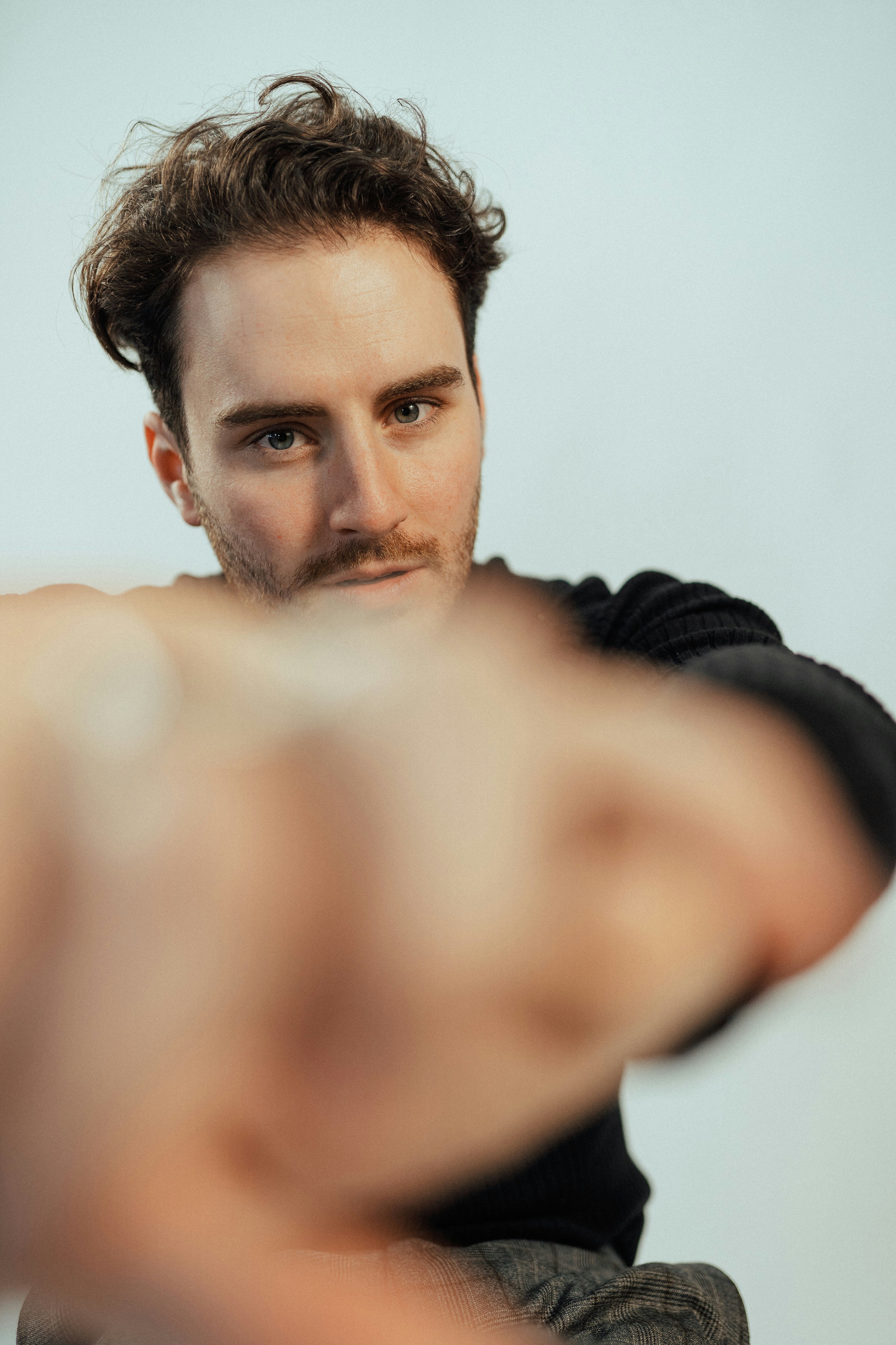 a man pointing a gun at the camera