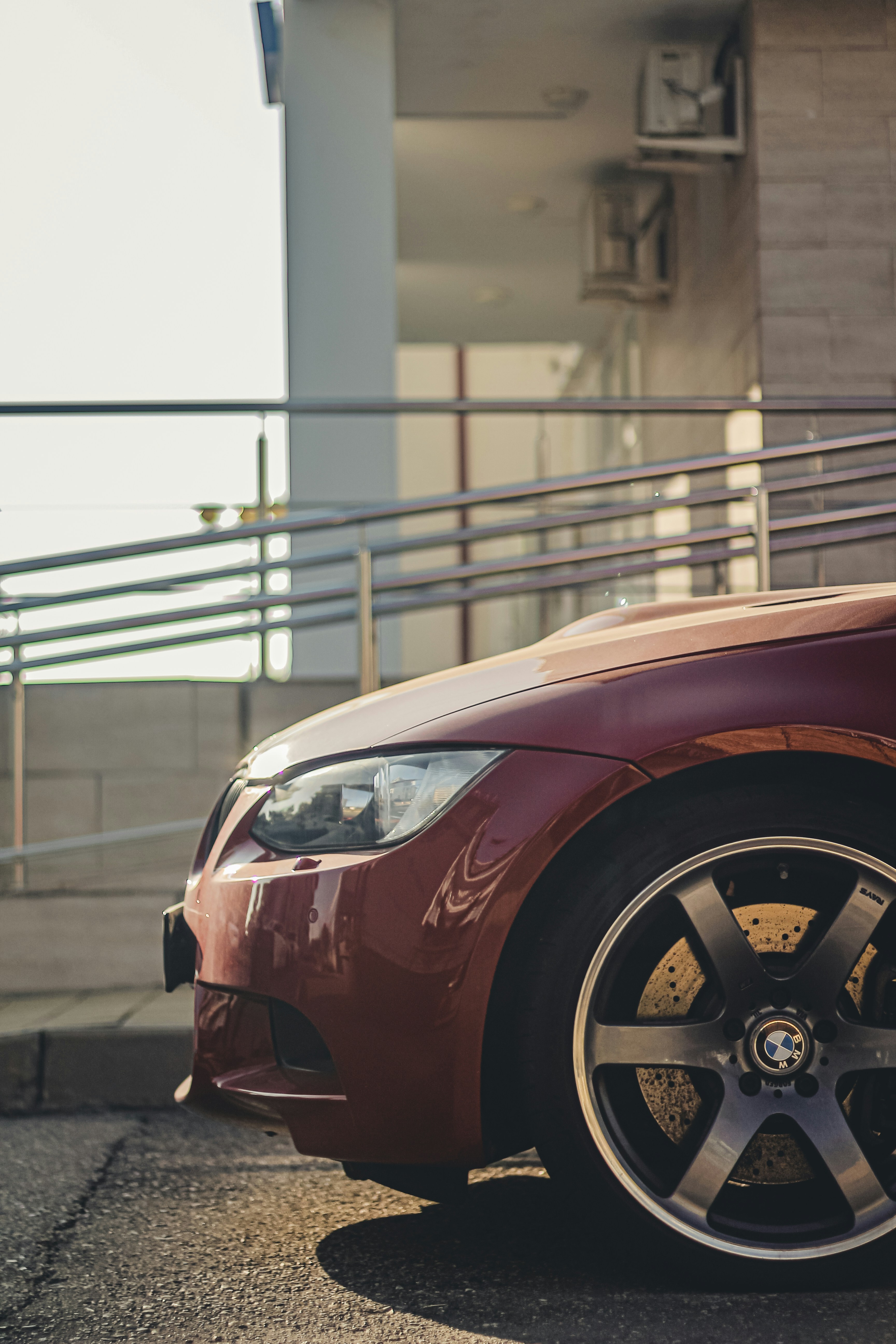 Red Dawn: A Red BMW Blocked by Urban Railings