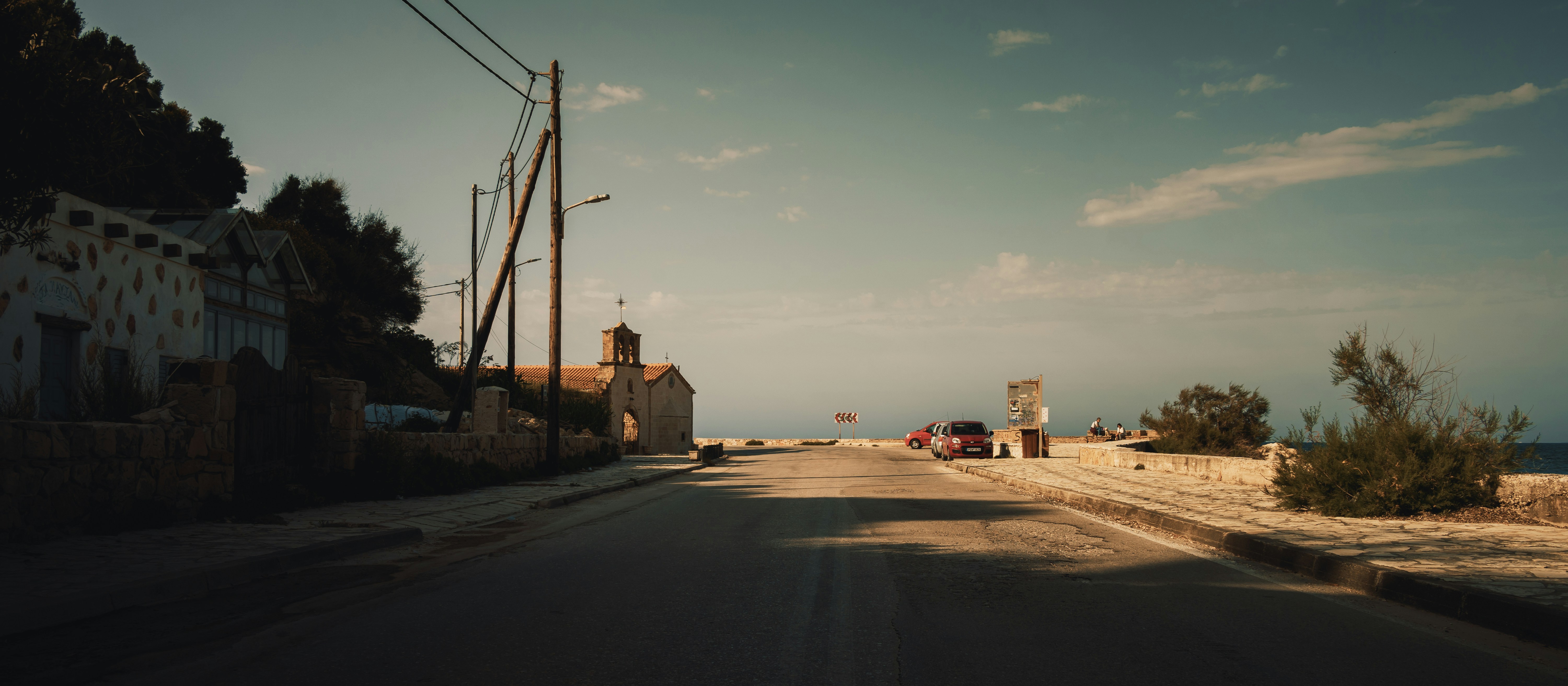 Horizon Road to the Sea: A Coastal Street Framed by Weathered Facades