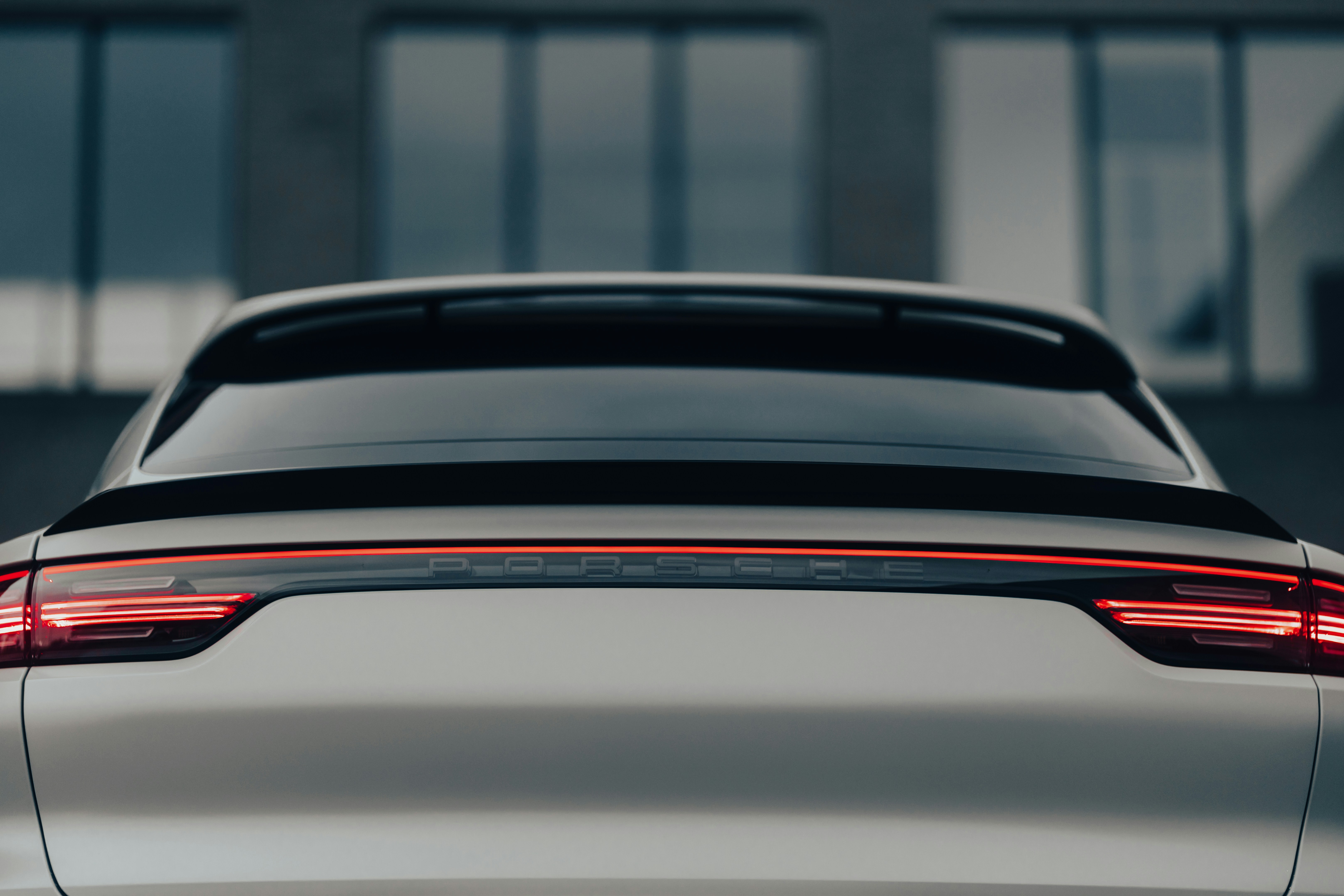 The rear end of a white car in a parking lot photo – Free Car Image on ...