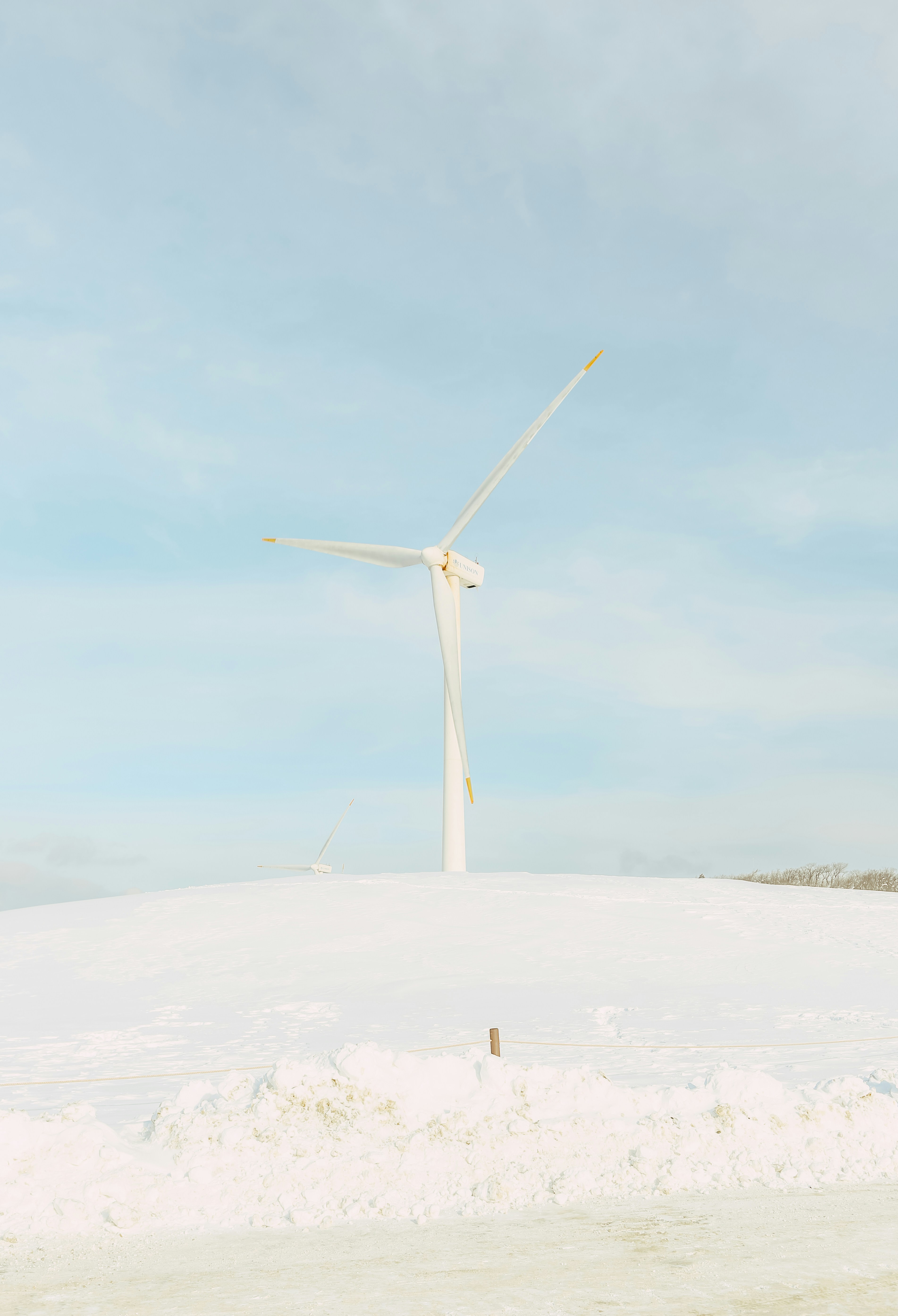 Windward Silence over Snow: A Wind Turbine Tops the White Hill