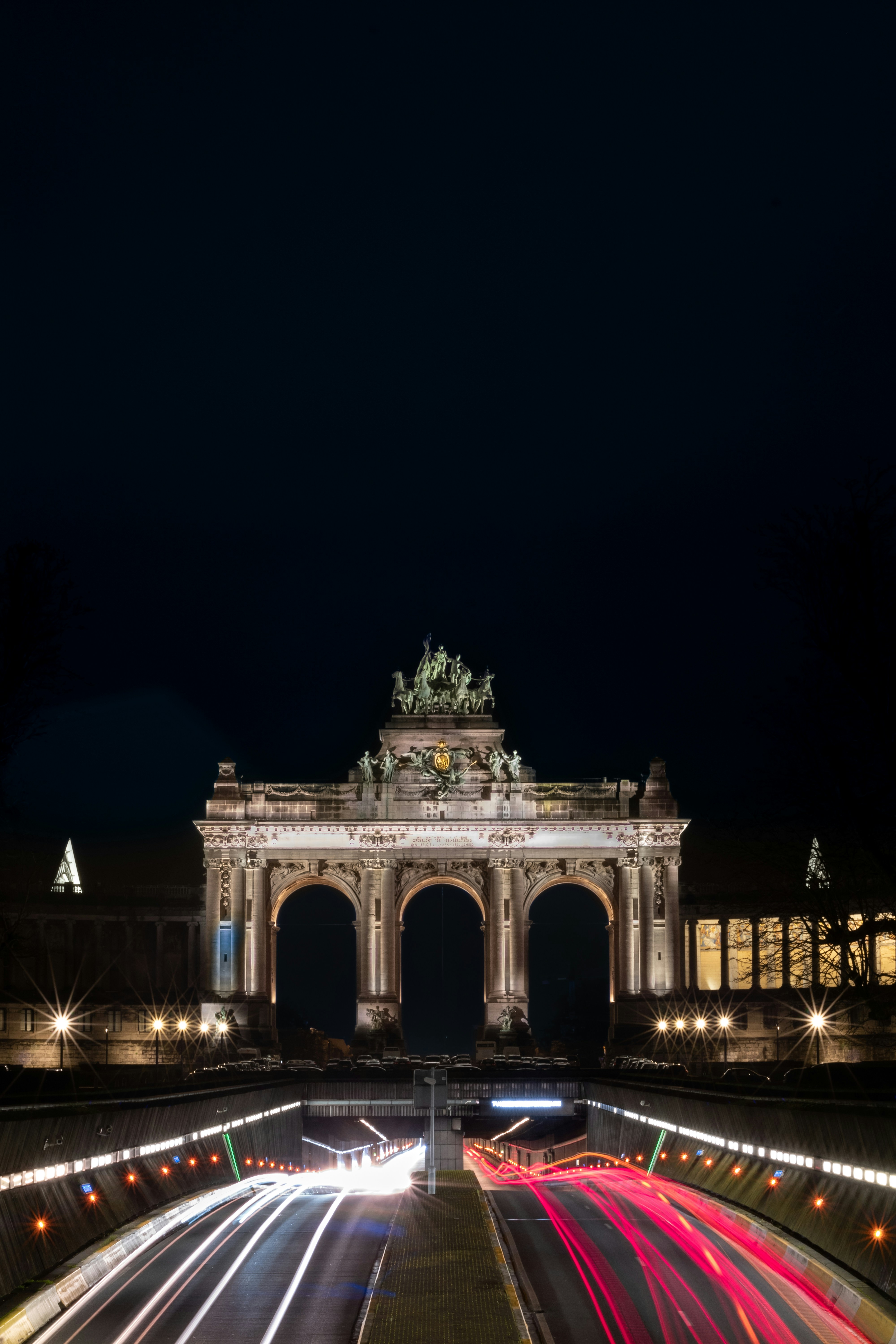 Arc in the Night: A Moonlit Triumph Framed by Moving Lights