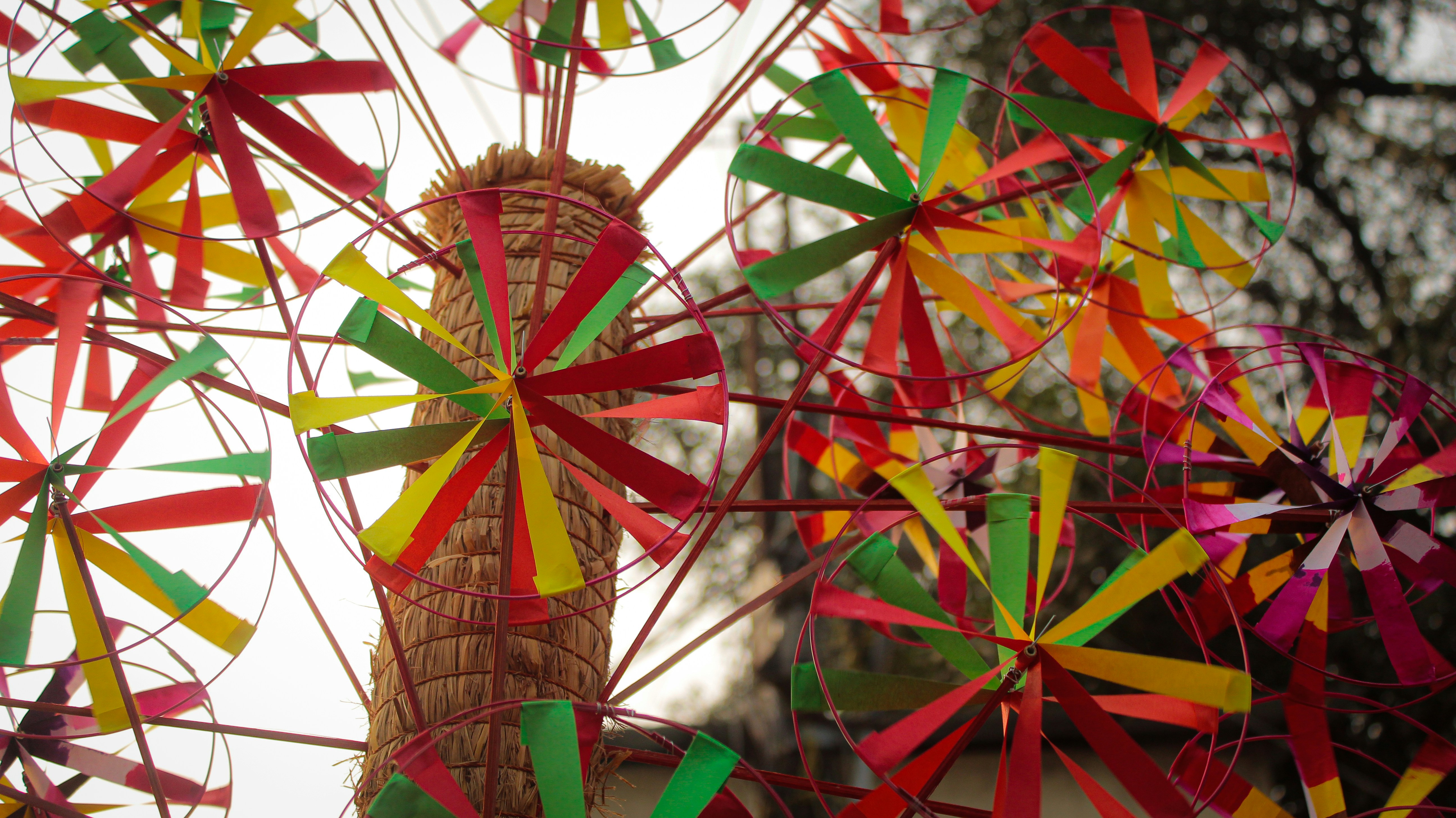 A bunch of colorful pinwheels hanging from a pole photo – Free Spring ...