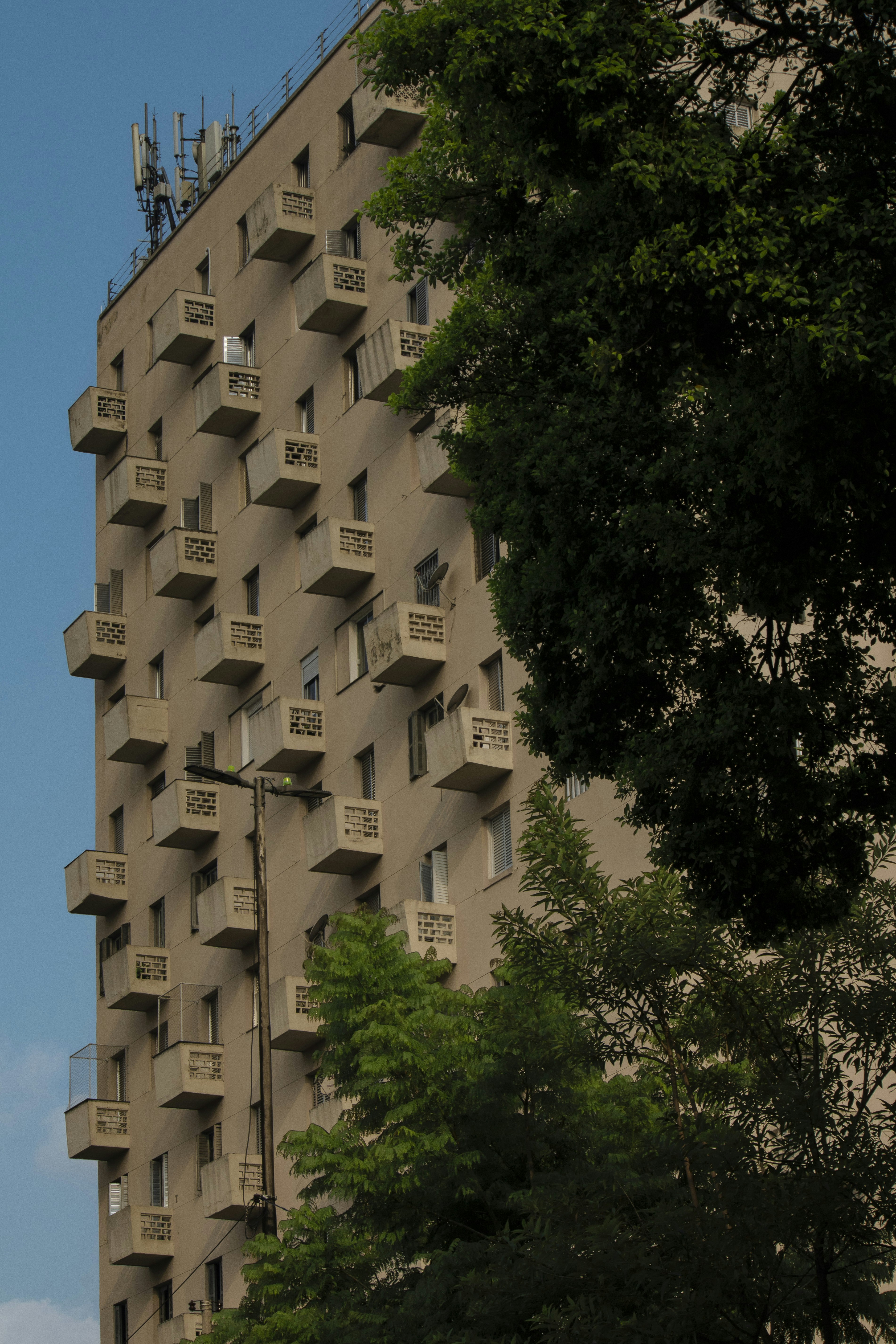 a tall building with balconies on the top of it