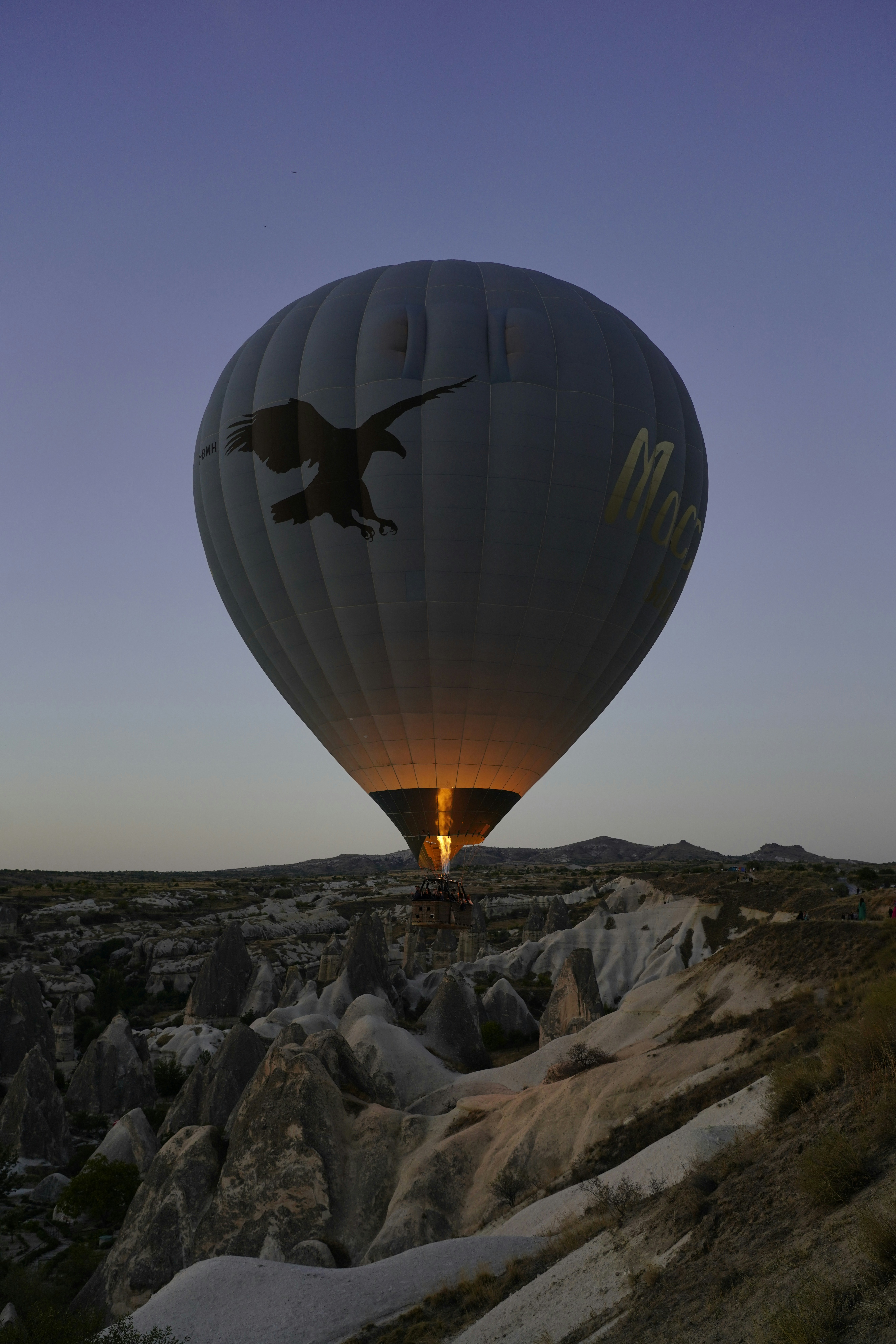 Dusk Ascent Over Cappadocia: Balloon Glows Above Fairy Chimneys