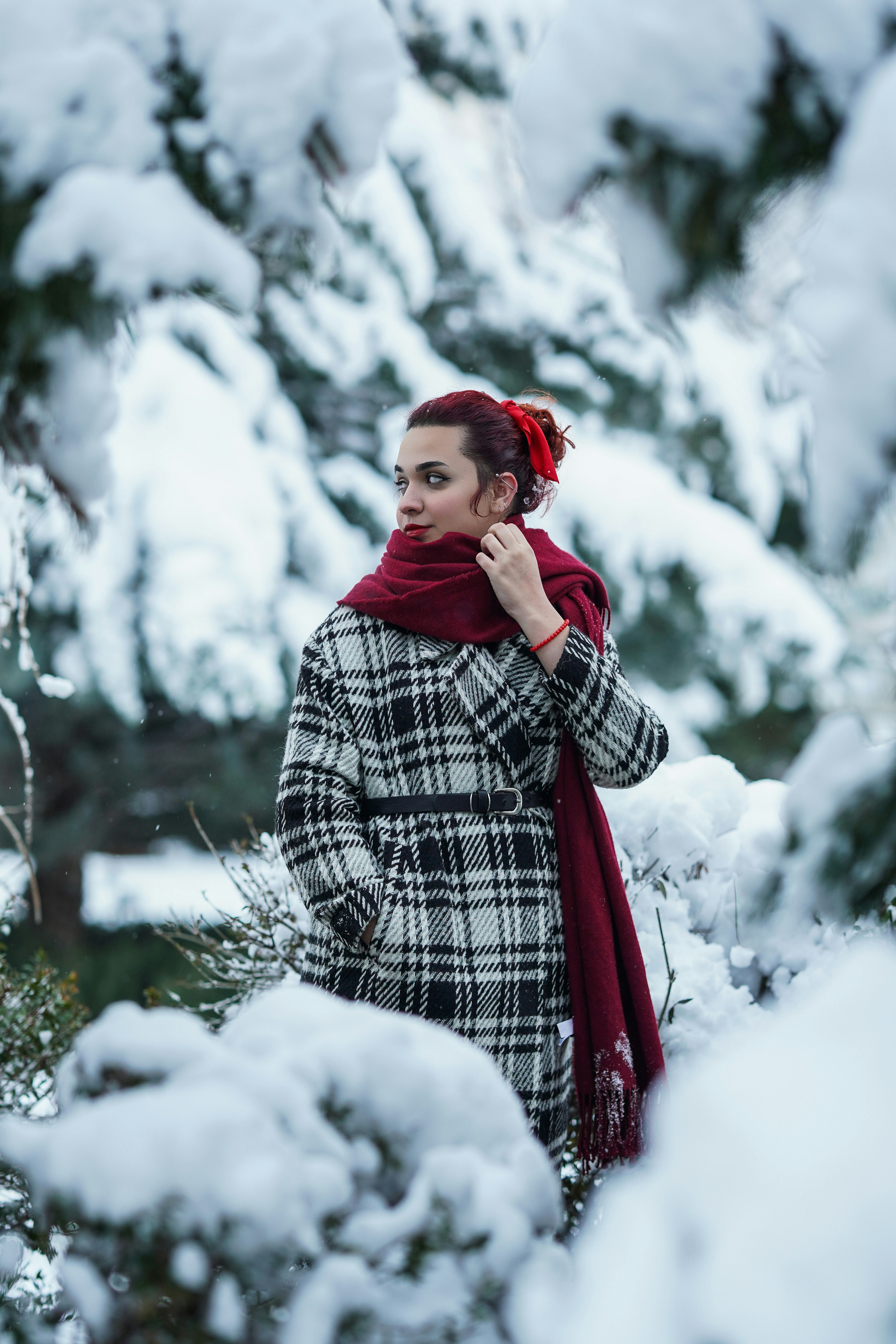 A woman standing in the snow wearing a coat and scarf photo – Free ...
