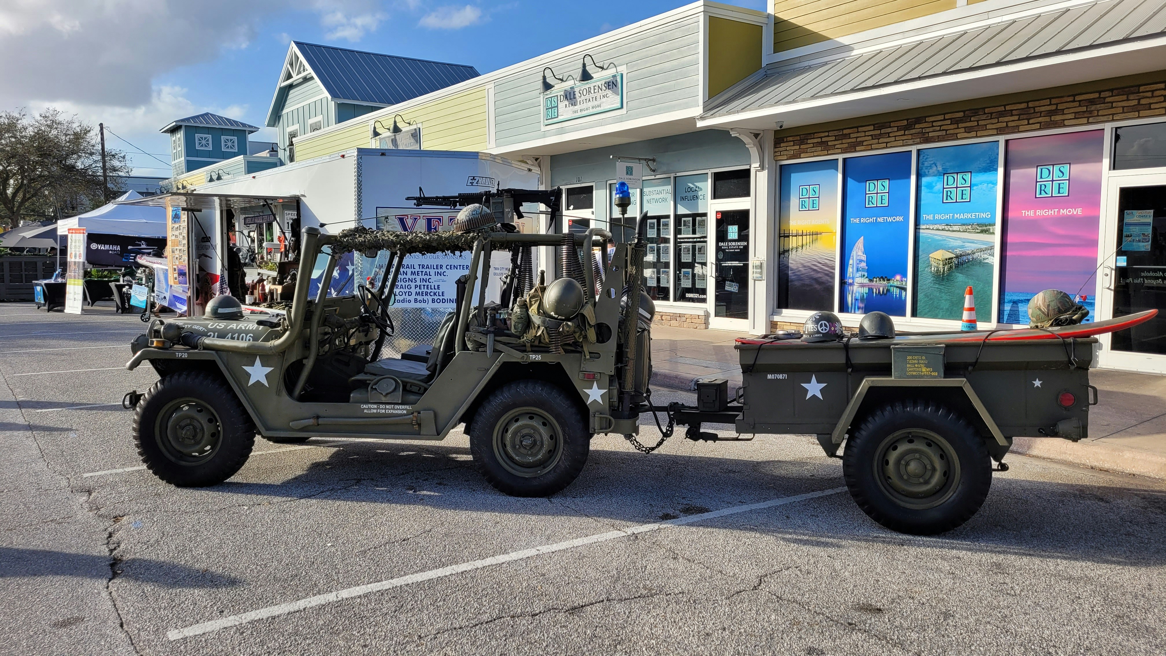 Pastel Strip and a Vintage Jeep: A WWII Hauler Staging in a Sunlit Town Street