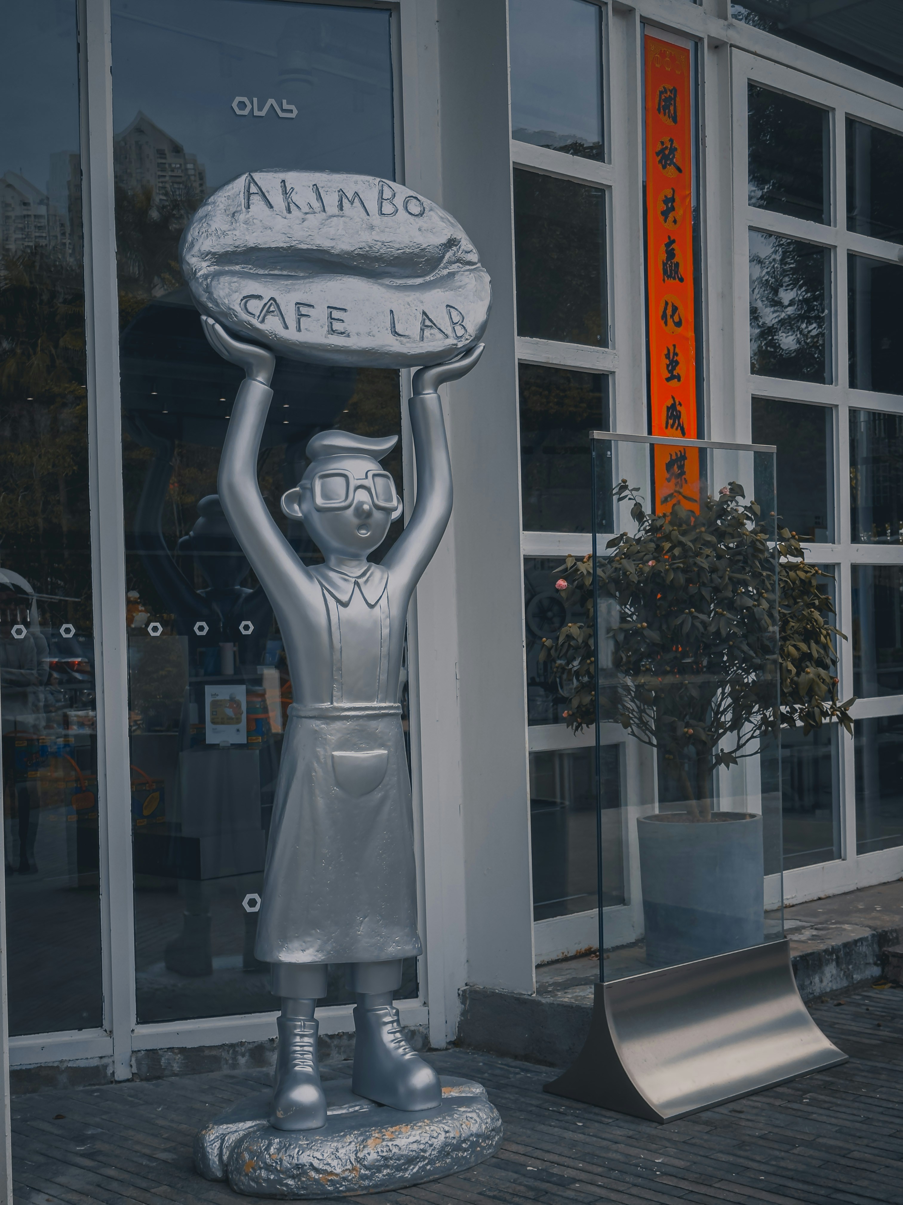 a statue of a person holding a sign in front of a building