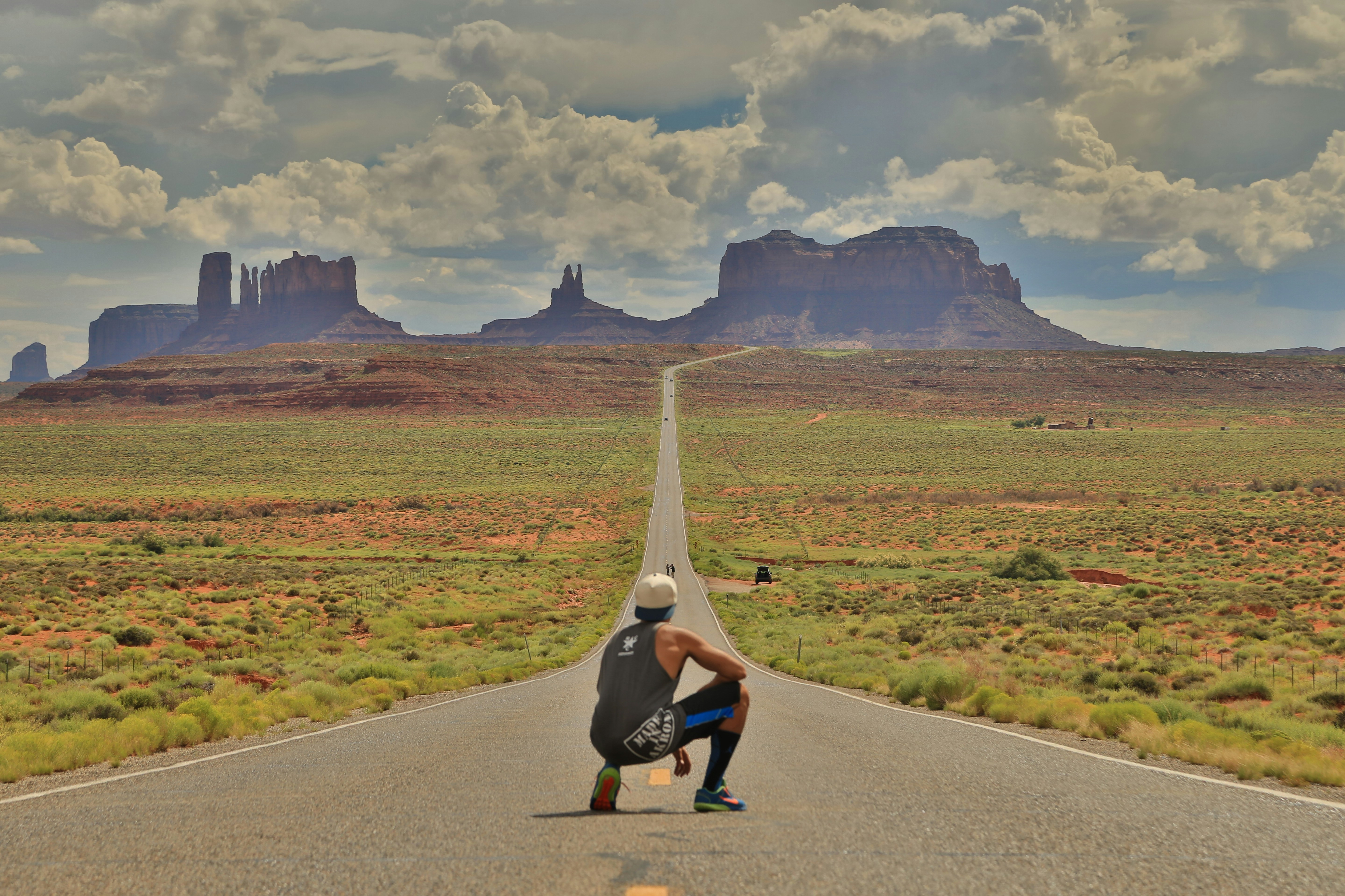 Centerline Convergence: A Traveler Halts the Desert Highway Toward Monument Valley