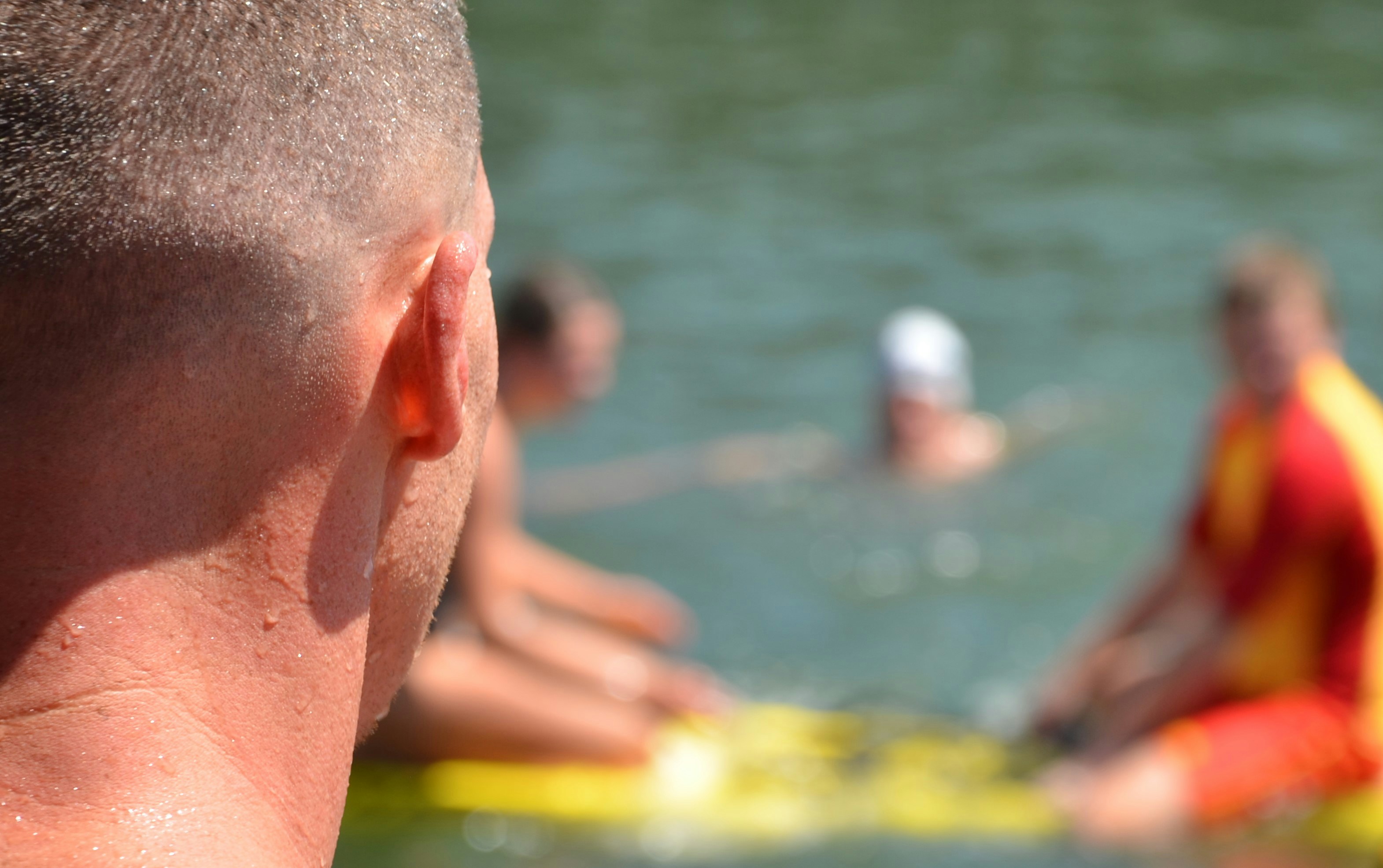 Close-Up of a Lifeguard's Perspective: Focus on the Onlookers in the Water