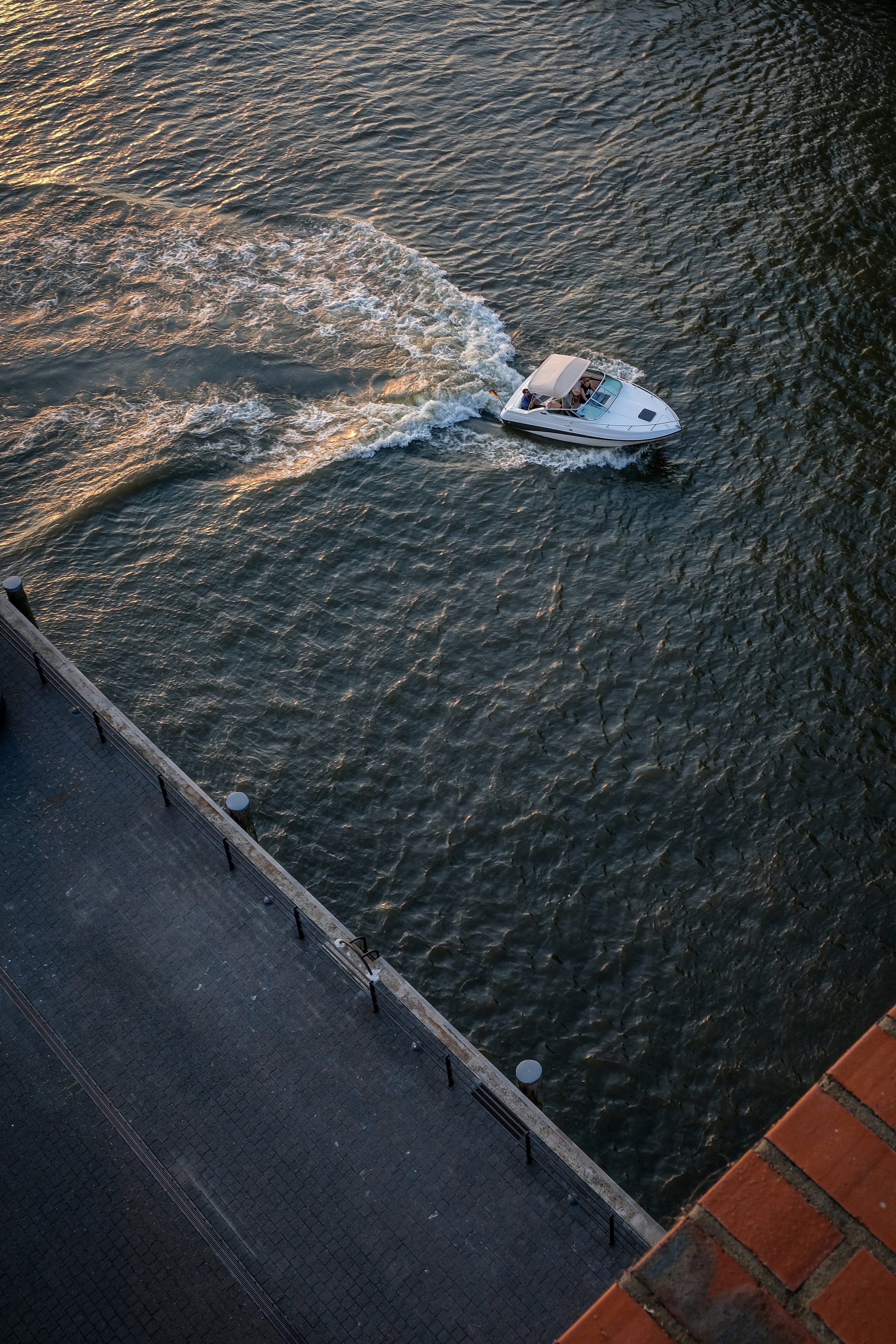 Whitespeed: a solitary motorboat skims the river at golden hour