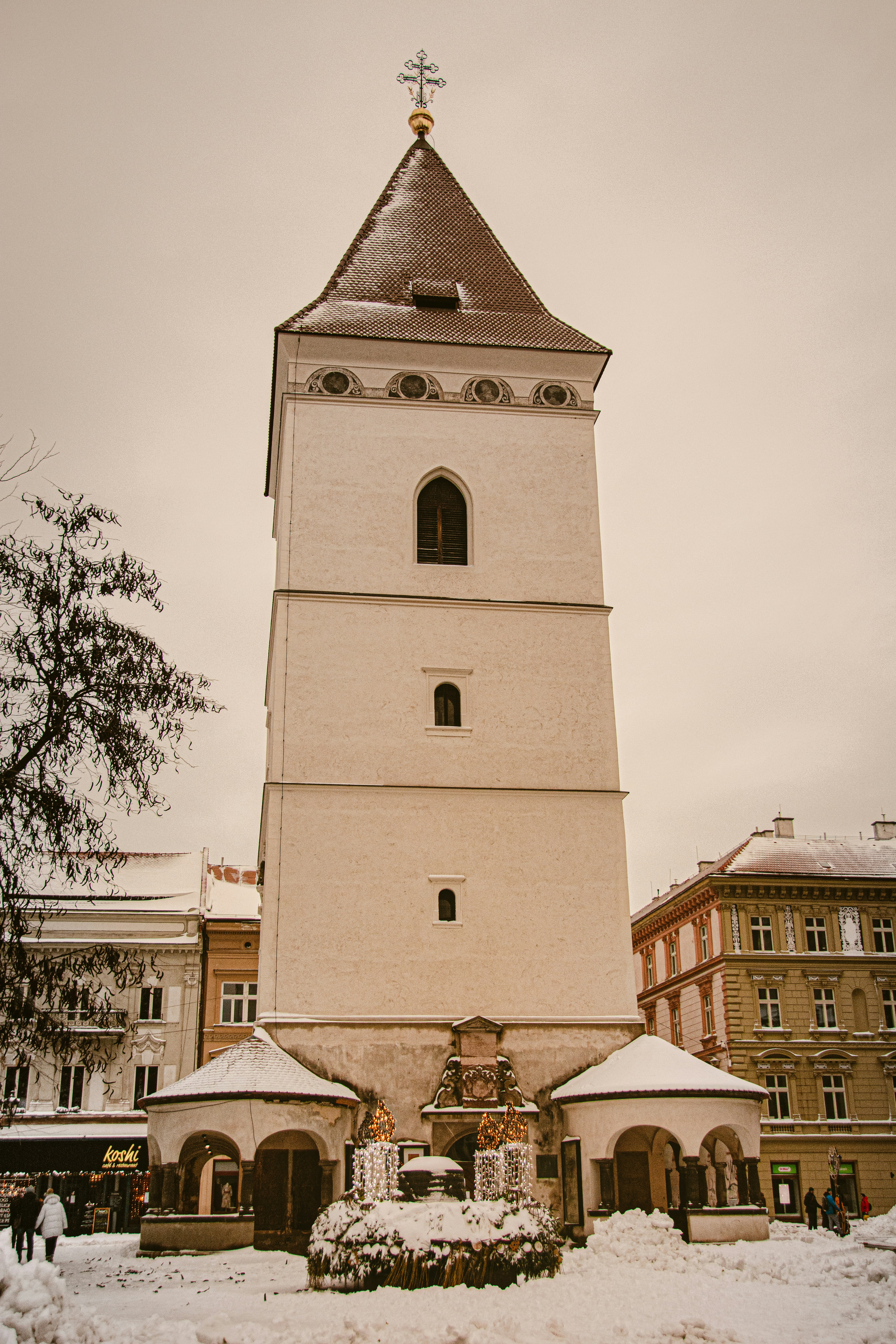 a tall white tower with a clock on it's side