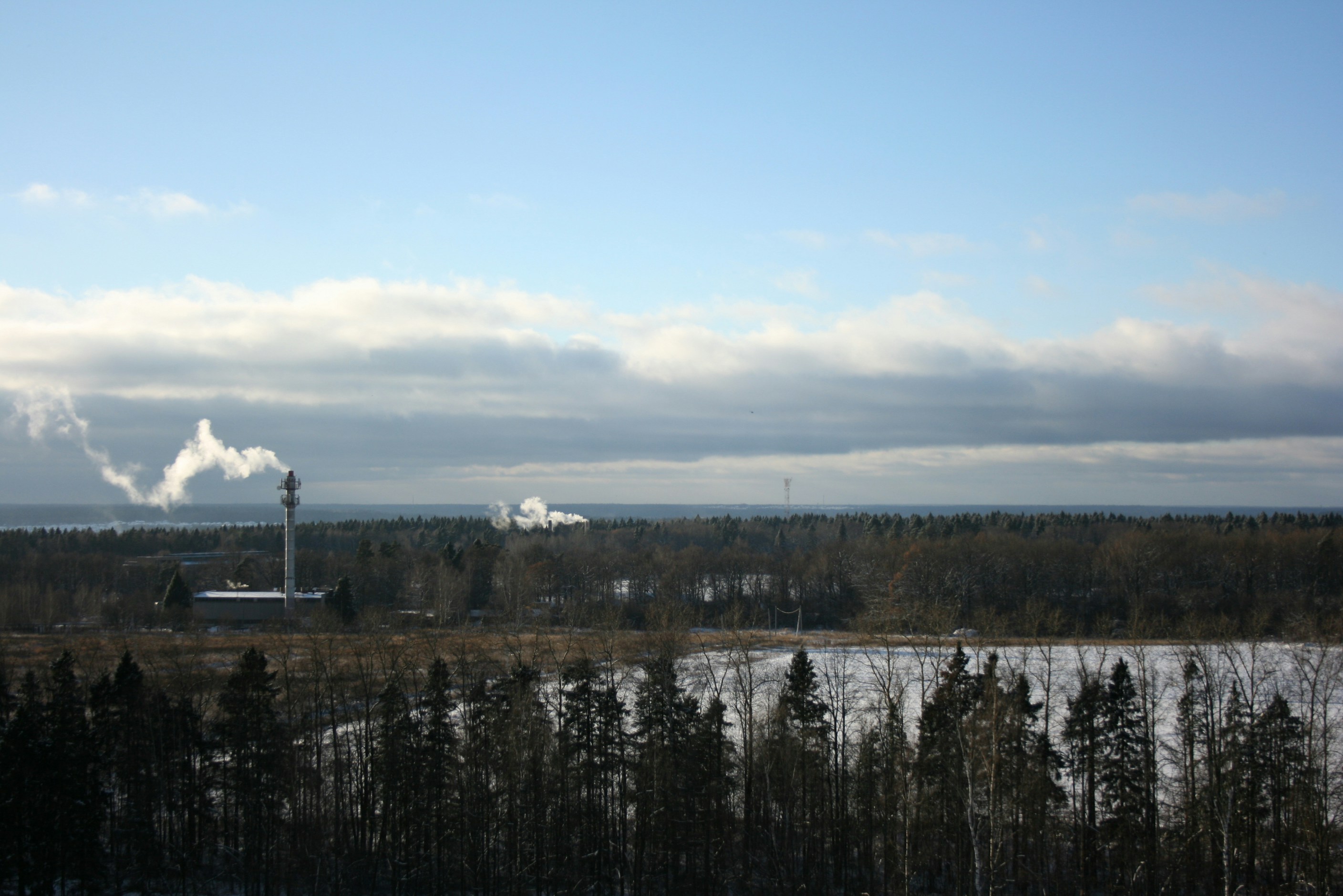 a factory with smoke coming out of it's stacks