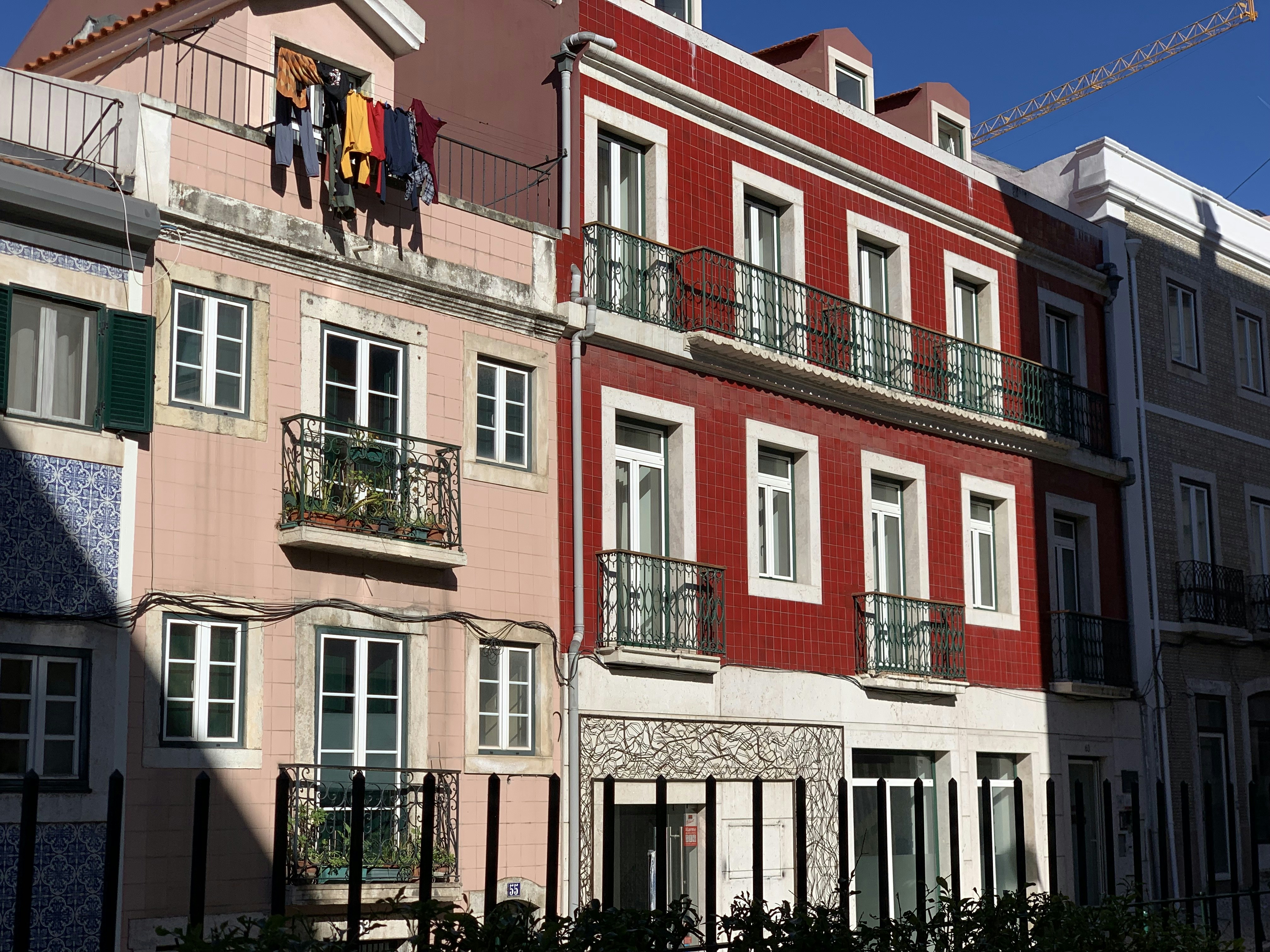 Colorful buildings with balconies and laundry hanging in the sun.