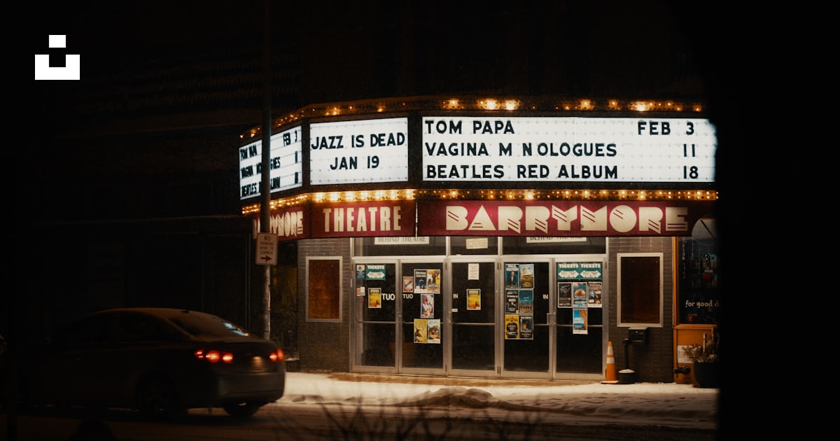 A Theater Marquee Lit Up At Night In The Snow Photo Free Cinema Image
