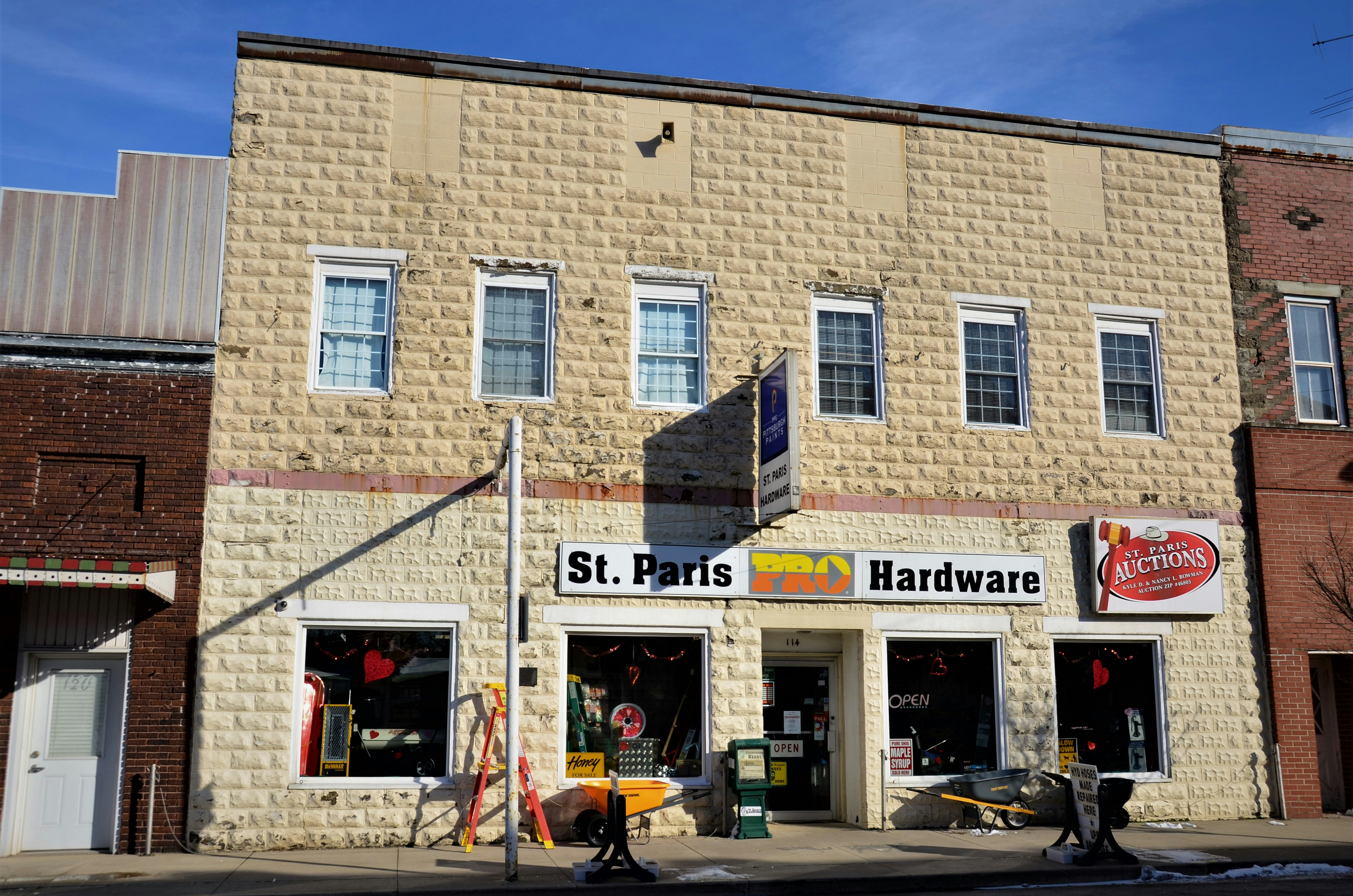 St. Paris Hardware on a Sunlit Main Street: A Quiet Brick-and-Stone Moment