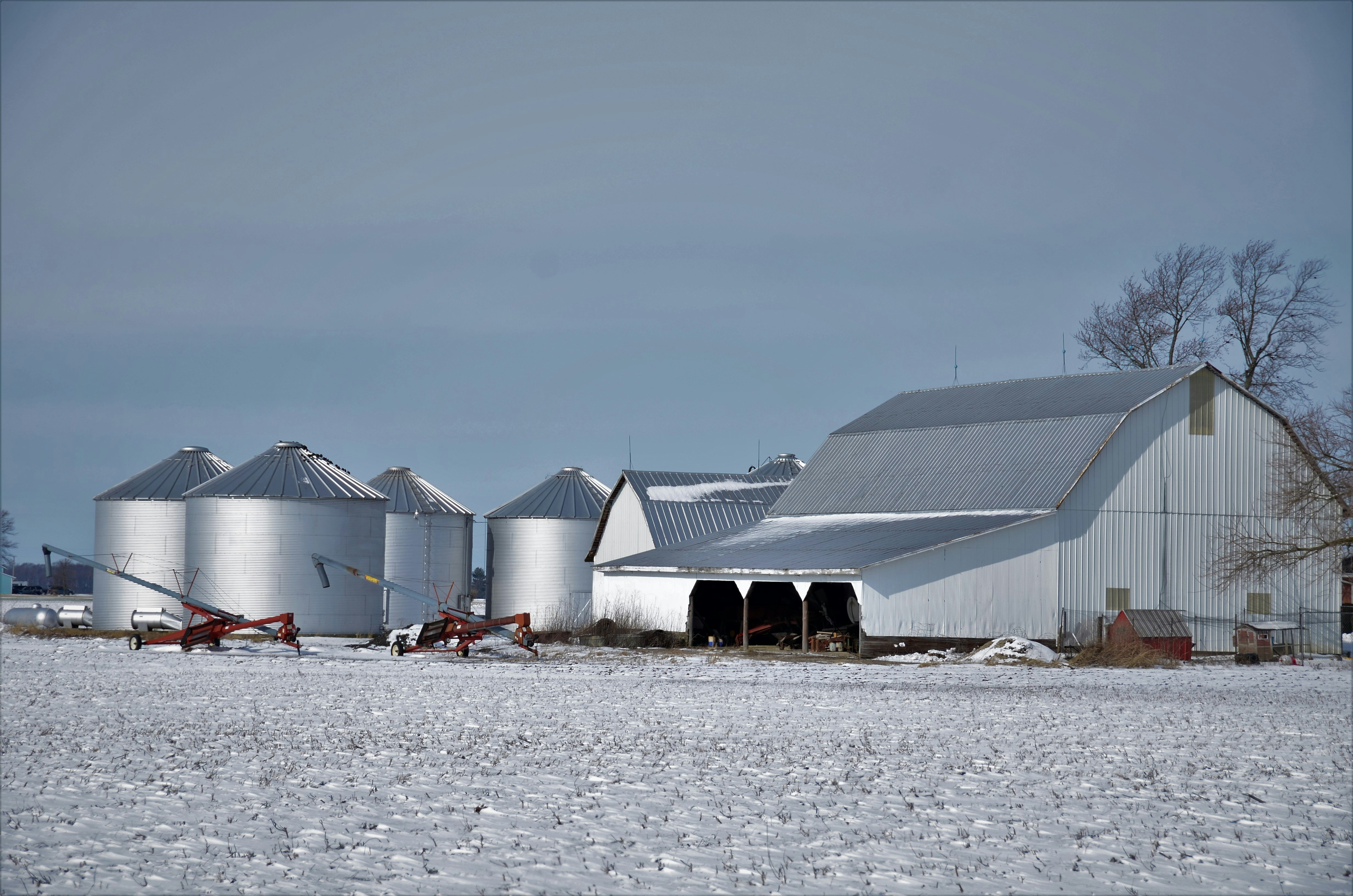 A farm with several silos in the snow photo – Free Shelter Image on ...