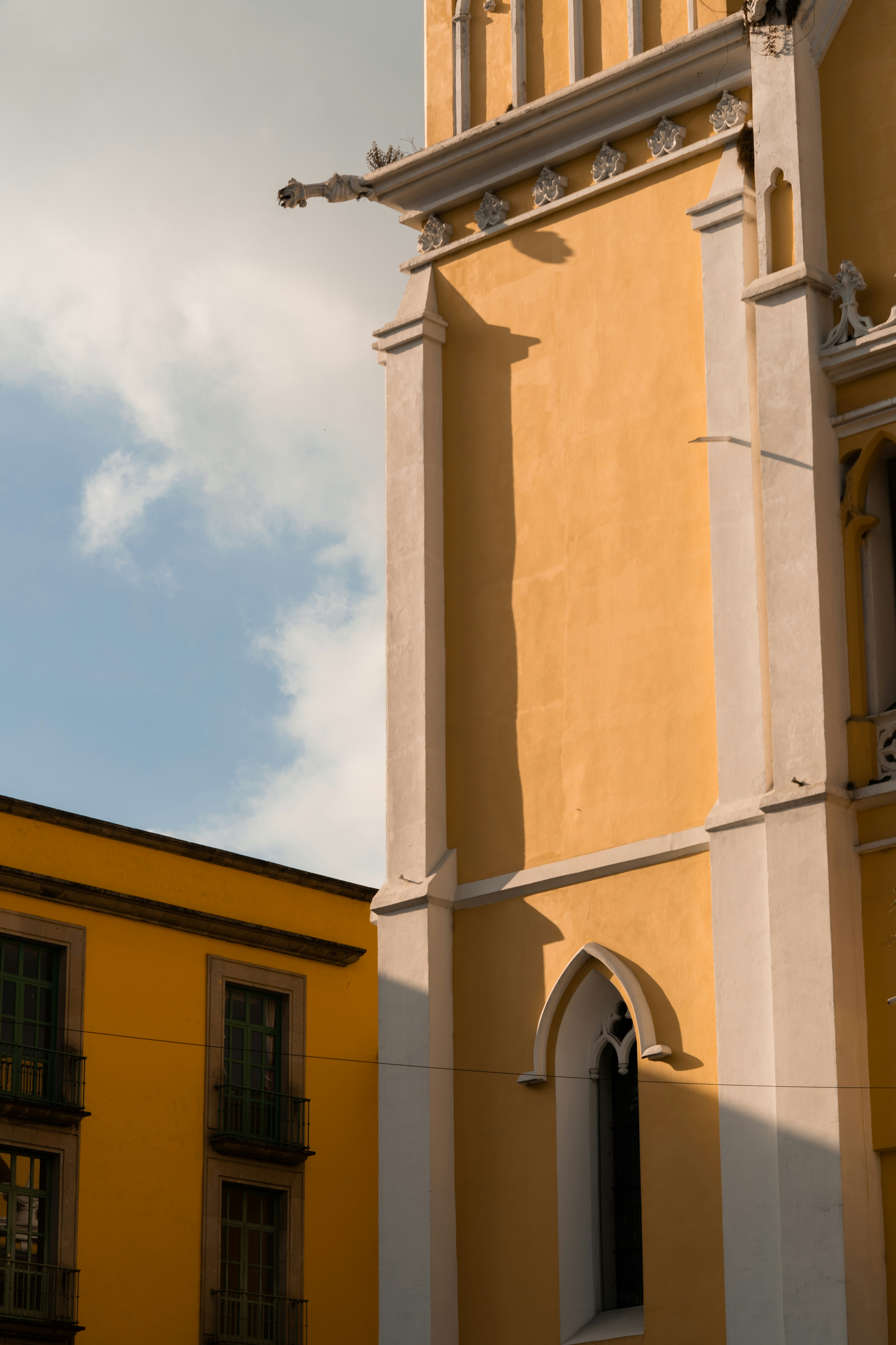 A tall yellow building with a clock on it's side photo – Free Xalapa ...