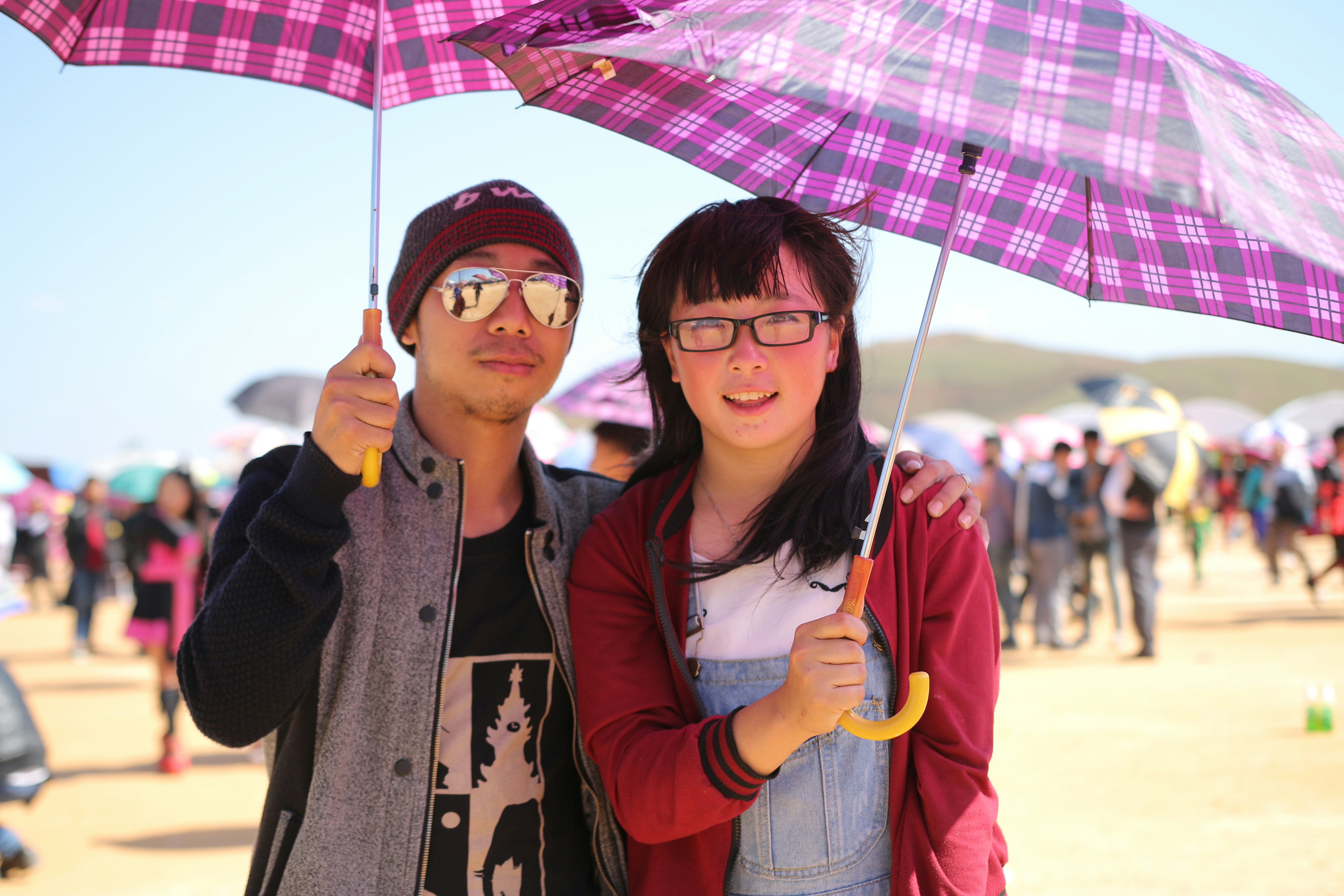 A man and a woman standing under an umbrella photo – Free Hmong couple ...