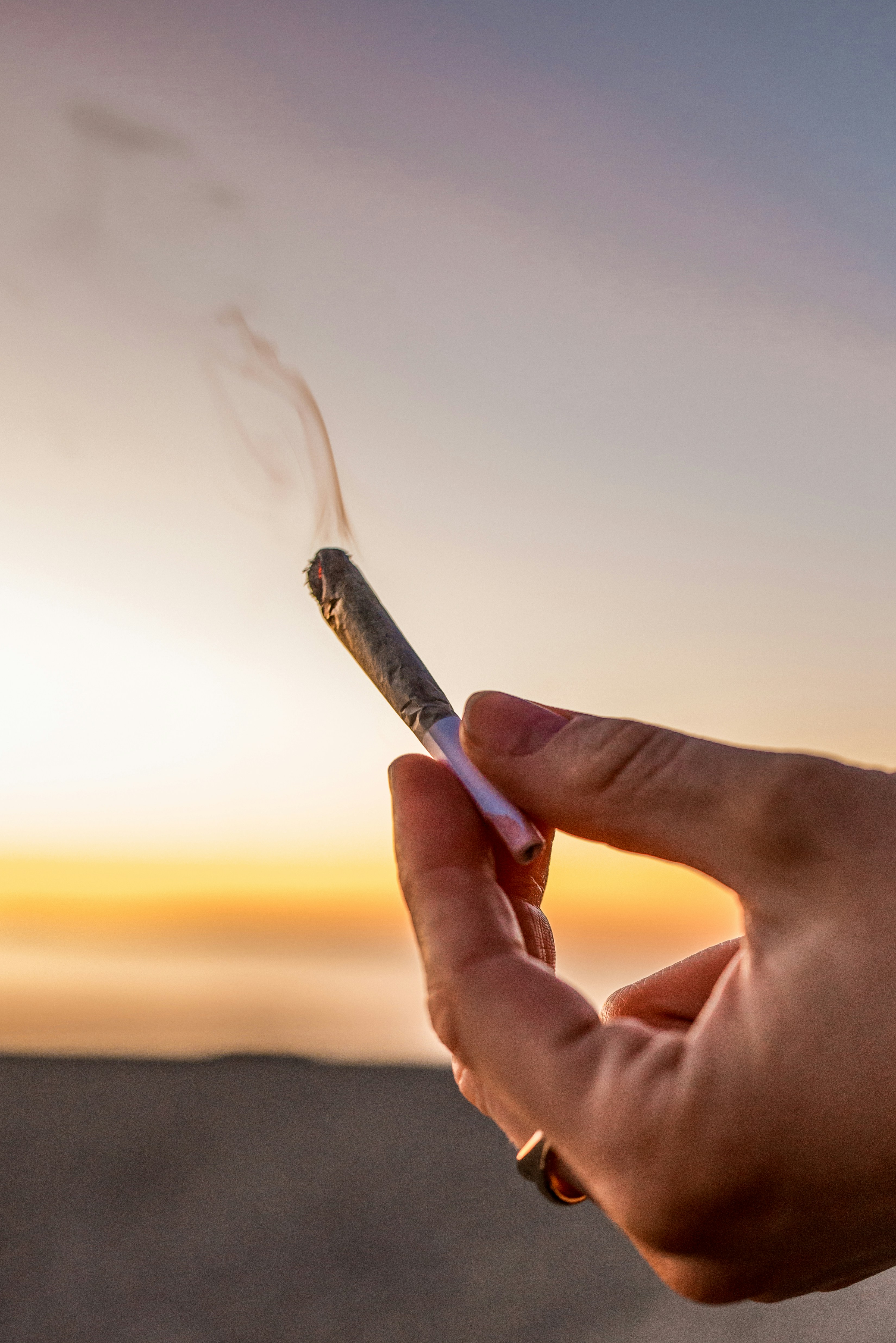 Ember on the Tip: A Glowing Burn of a Cigarette Tip at Sunset