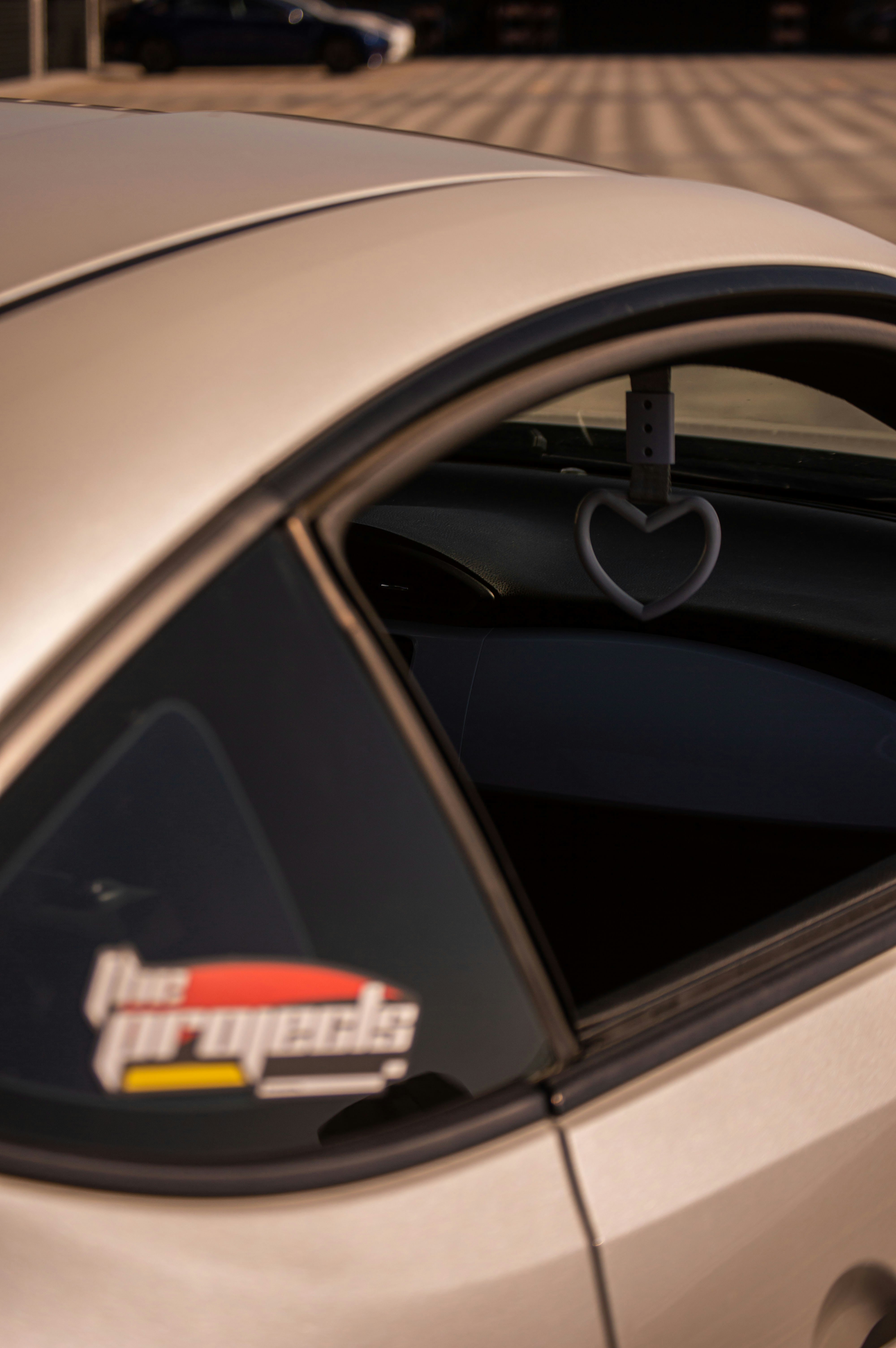 A silver car with a heart sticker on the window photo – Free Car Image ...
