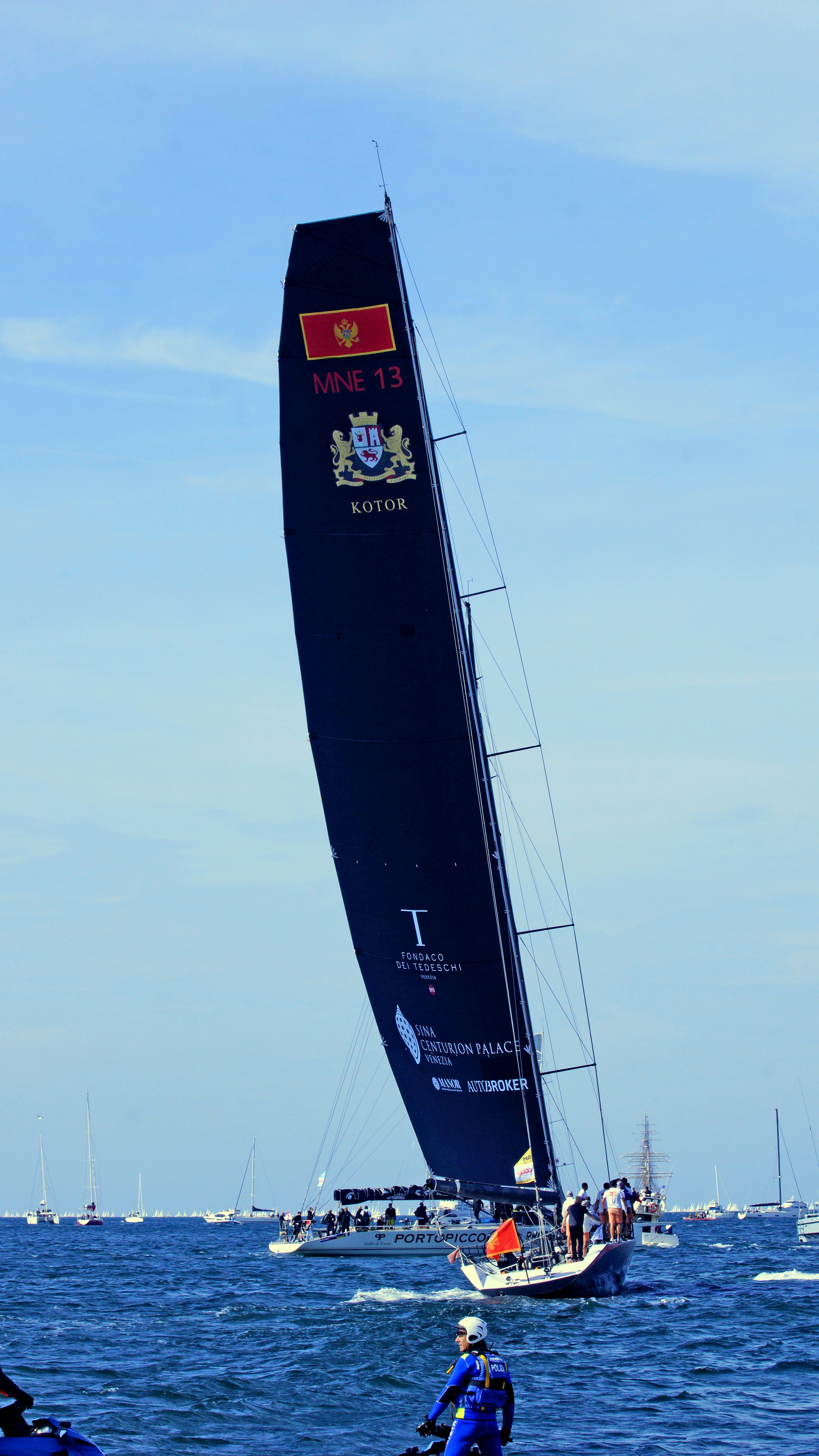 A sailboat with a flag on it sailing in the ocean photo – Free Image on ...