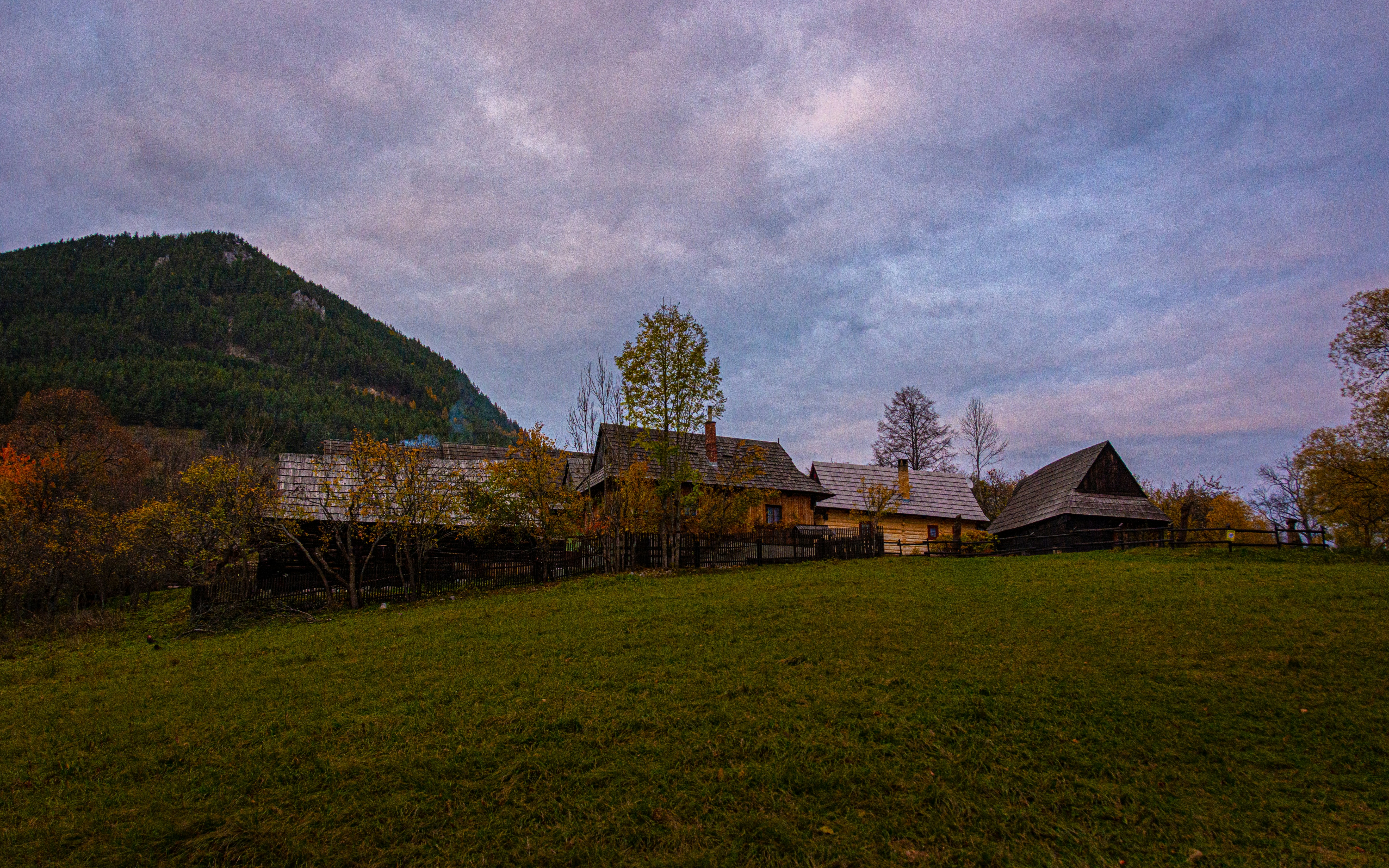 A large grassy field with a house on top of it photo – Free Building ...