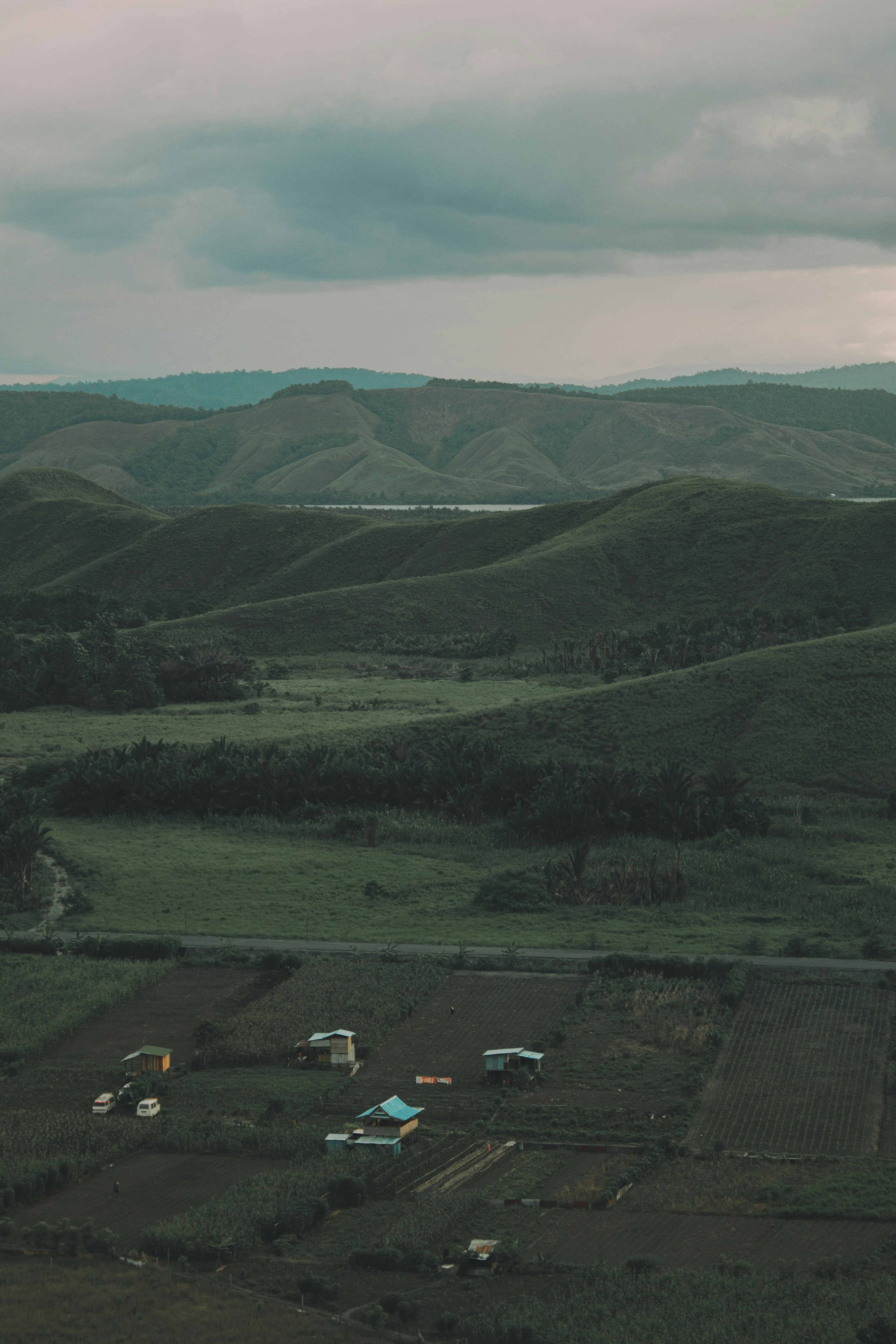An aerial view of a field and mountains photo – Free Bukit tungku wiri ...