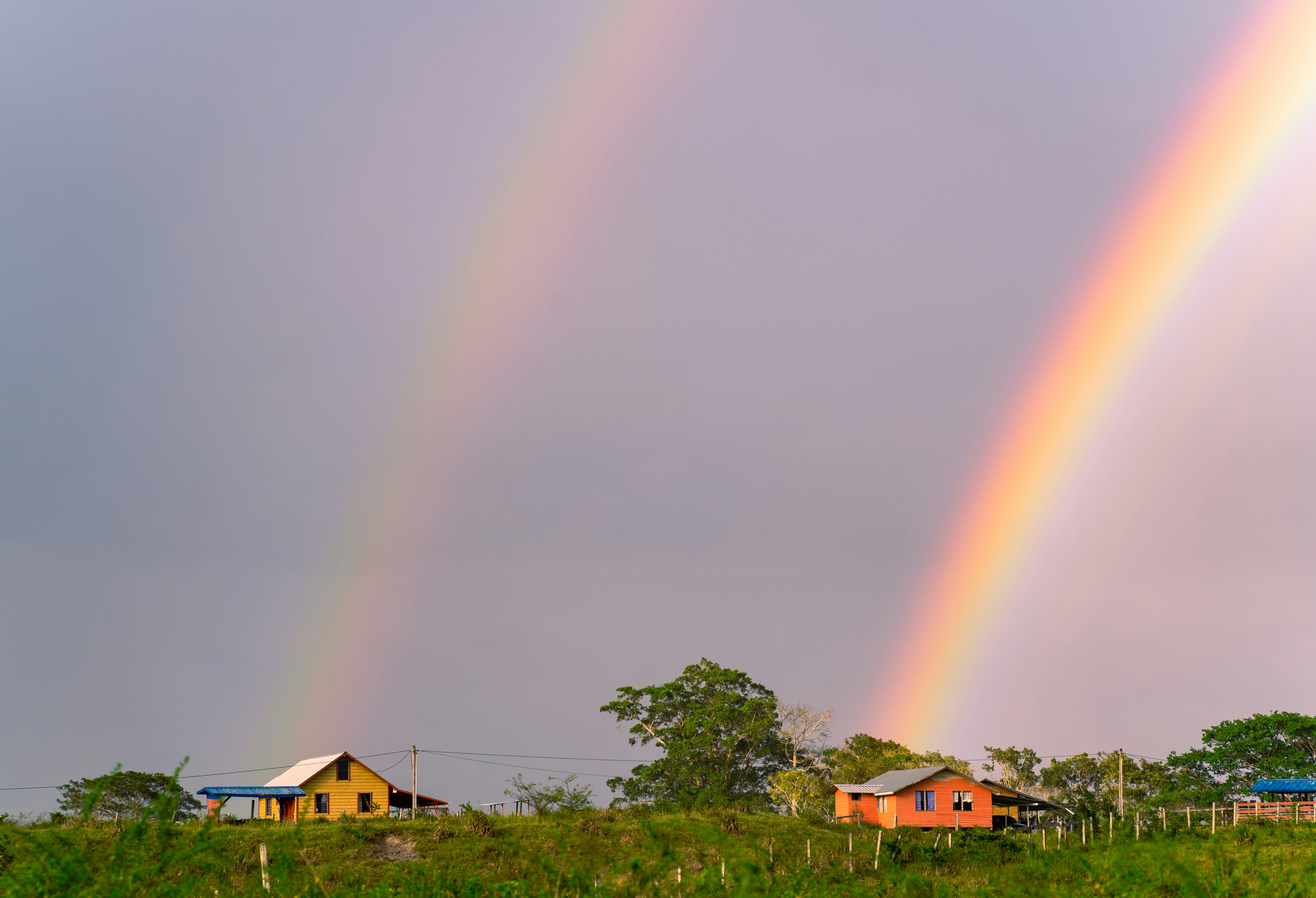 Twin Rainbows Over a Quiet Rural Homestead