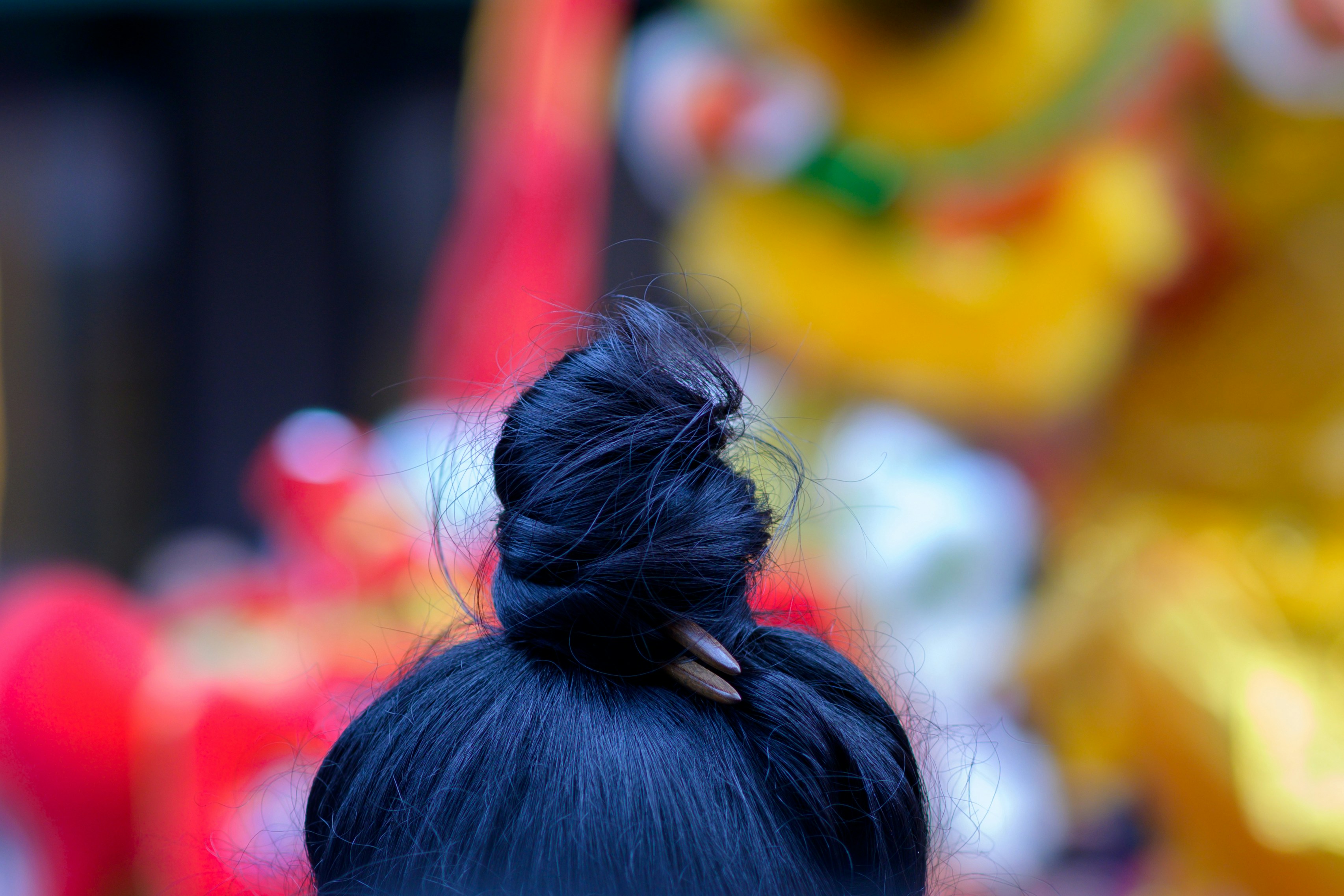 Top Knot Against a Vivid Carnival Blur