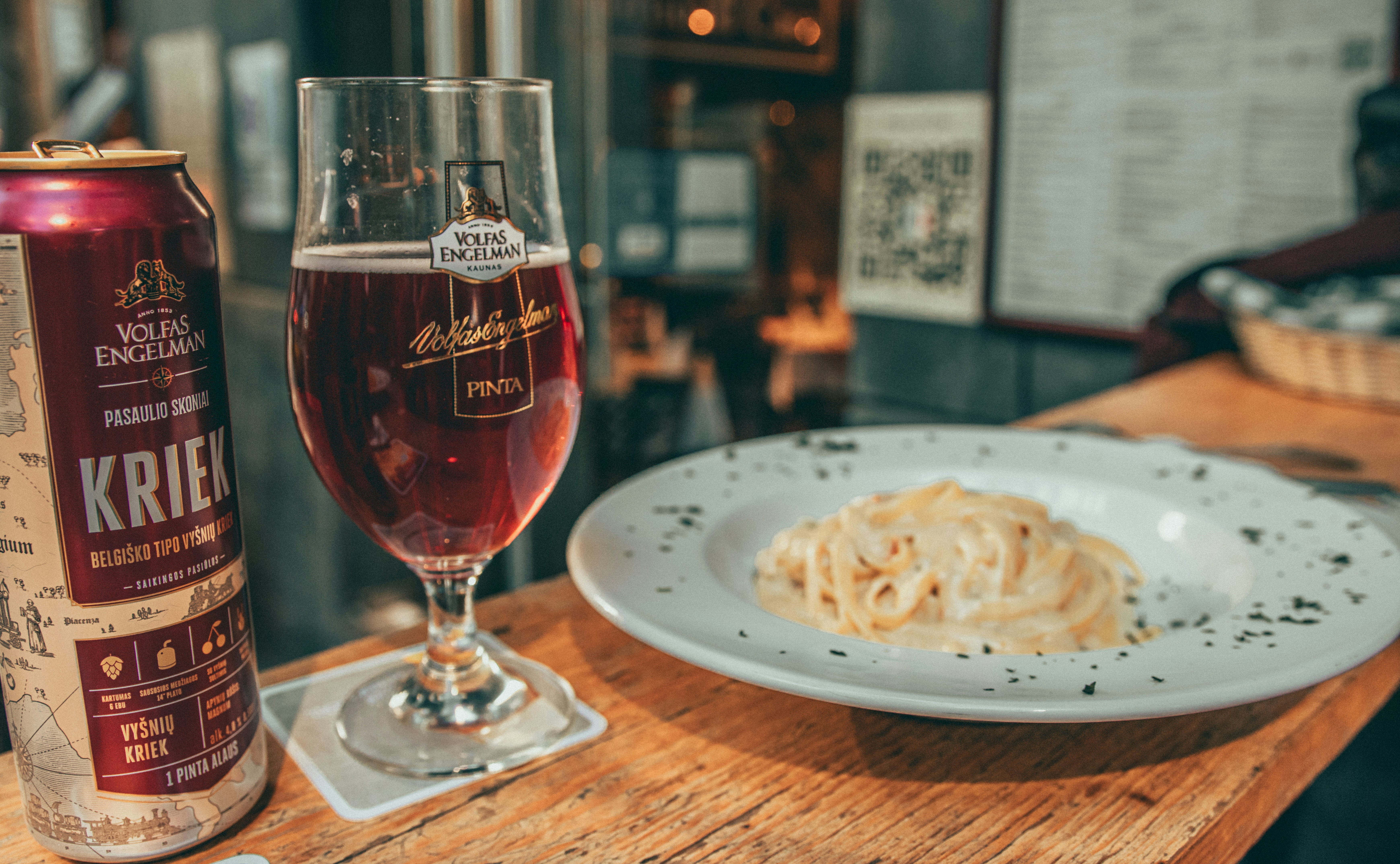 Crimson Draft and Creamy Pasta on a Rustic Café Counter