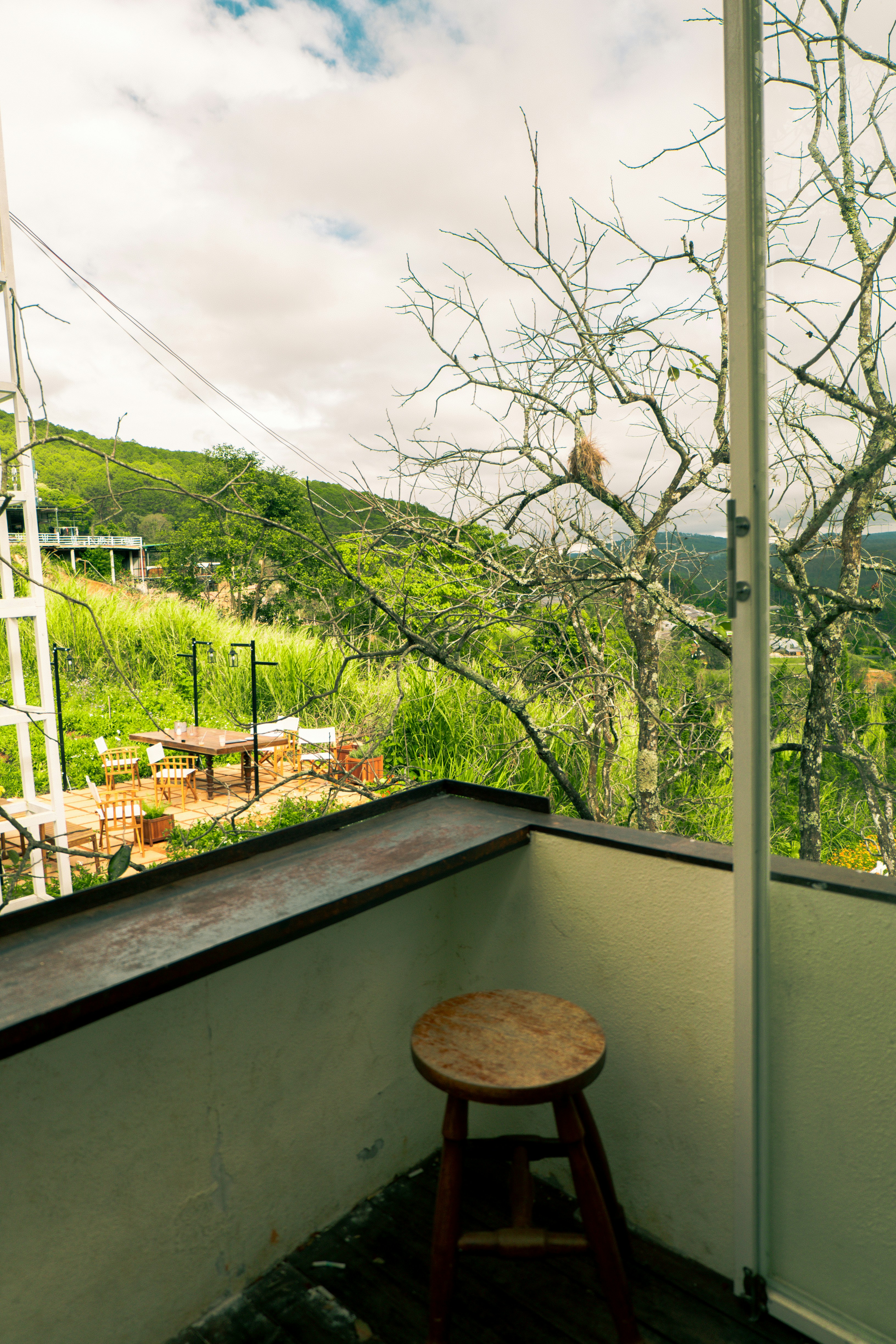 A wooden stool sitting on top of a balcony photo – Free Balcony Image ...