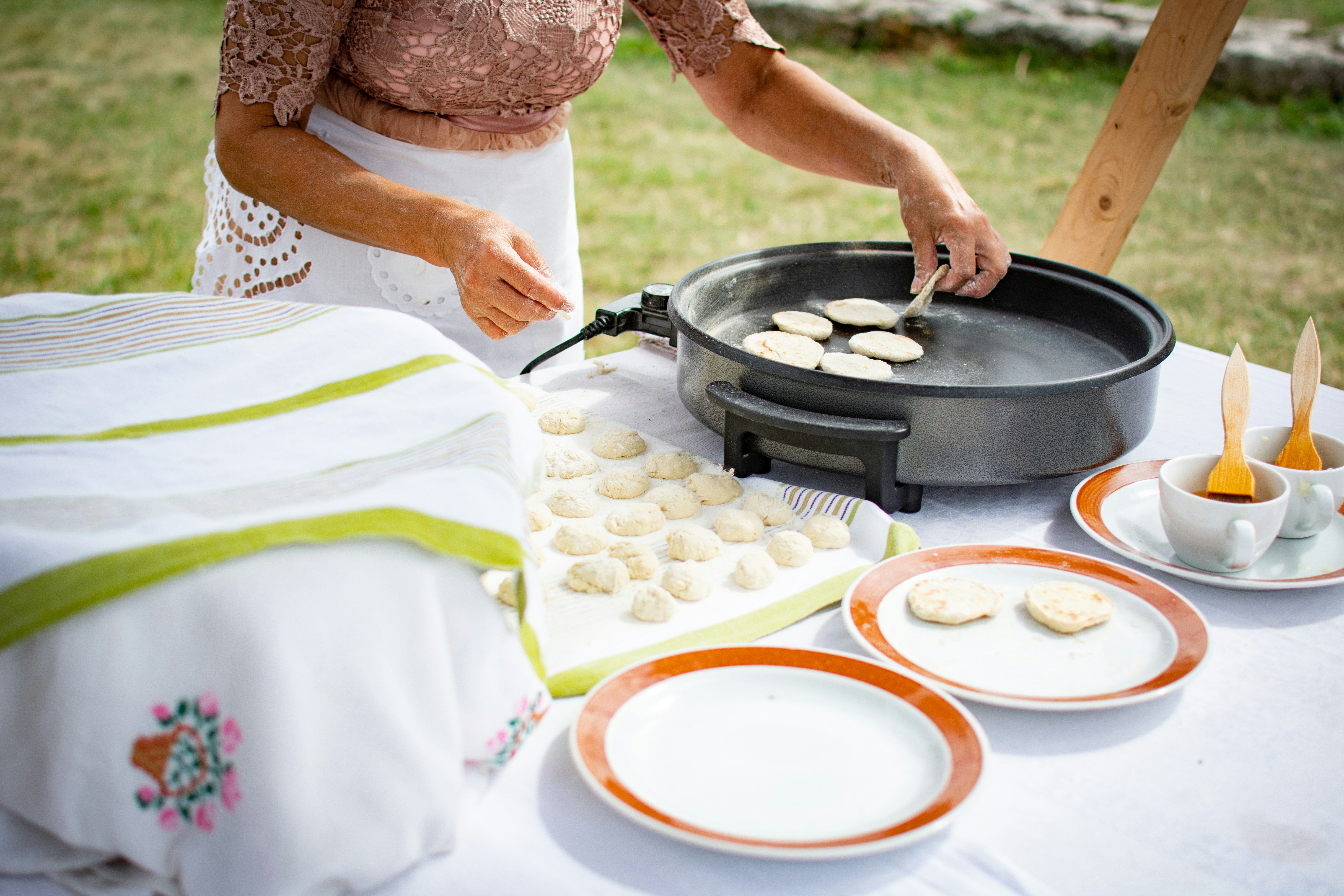 A woman is cooking food on a grill photo – Free Food Image on Unsplash