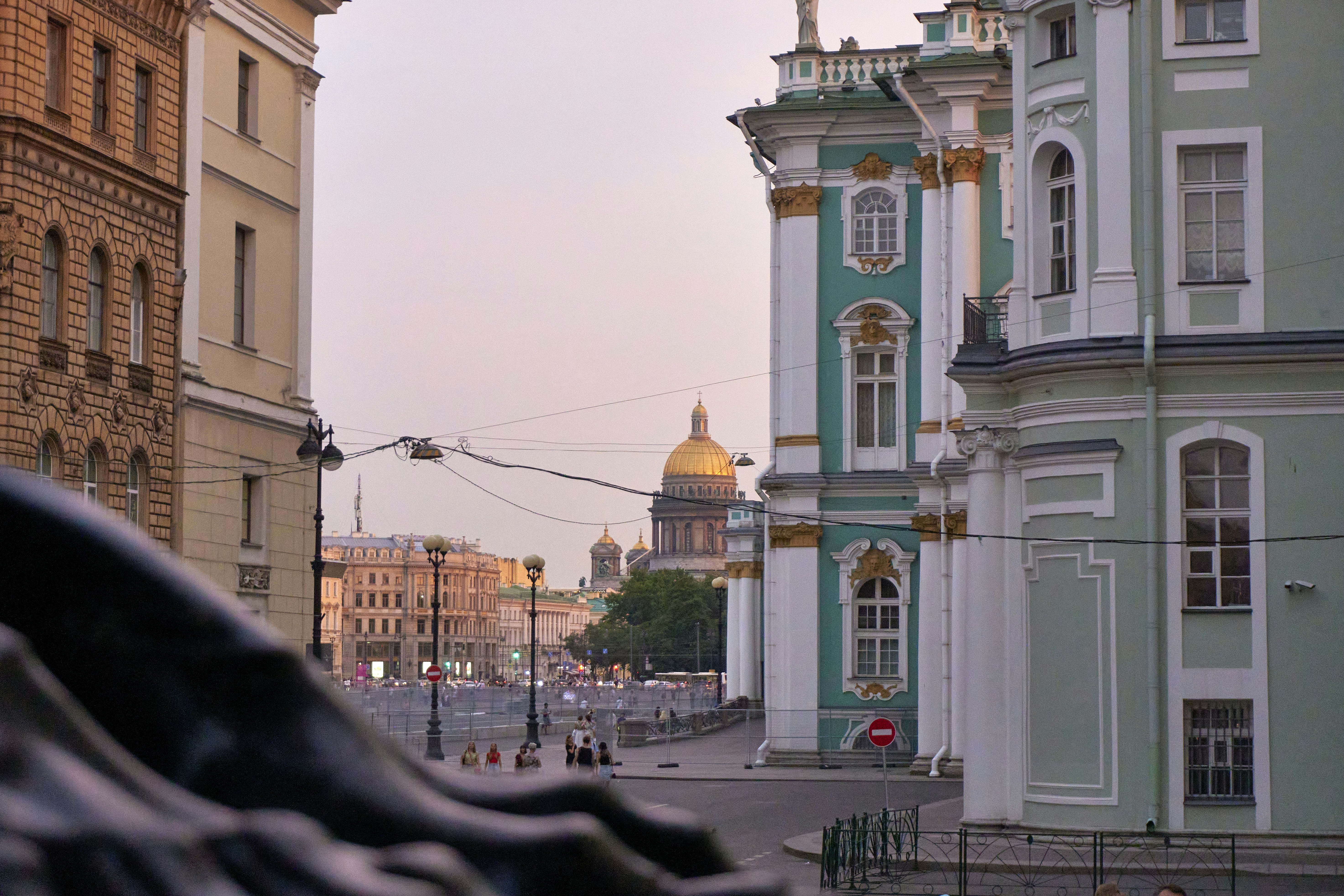 a view of a city street with a clock tower in the background