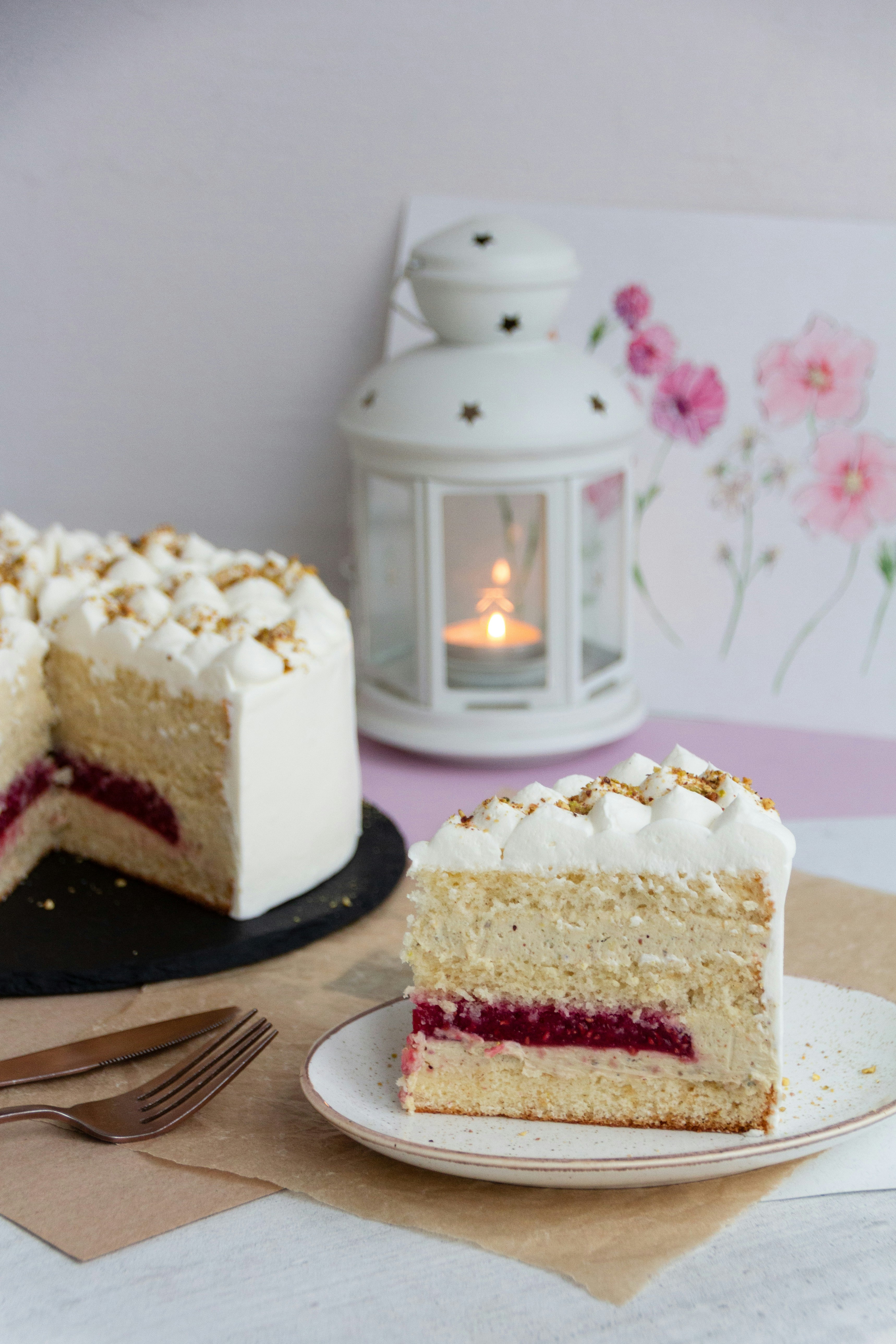 Vanilla Cake Slice with Raspberry Core, framed by Lantern Glow