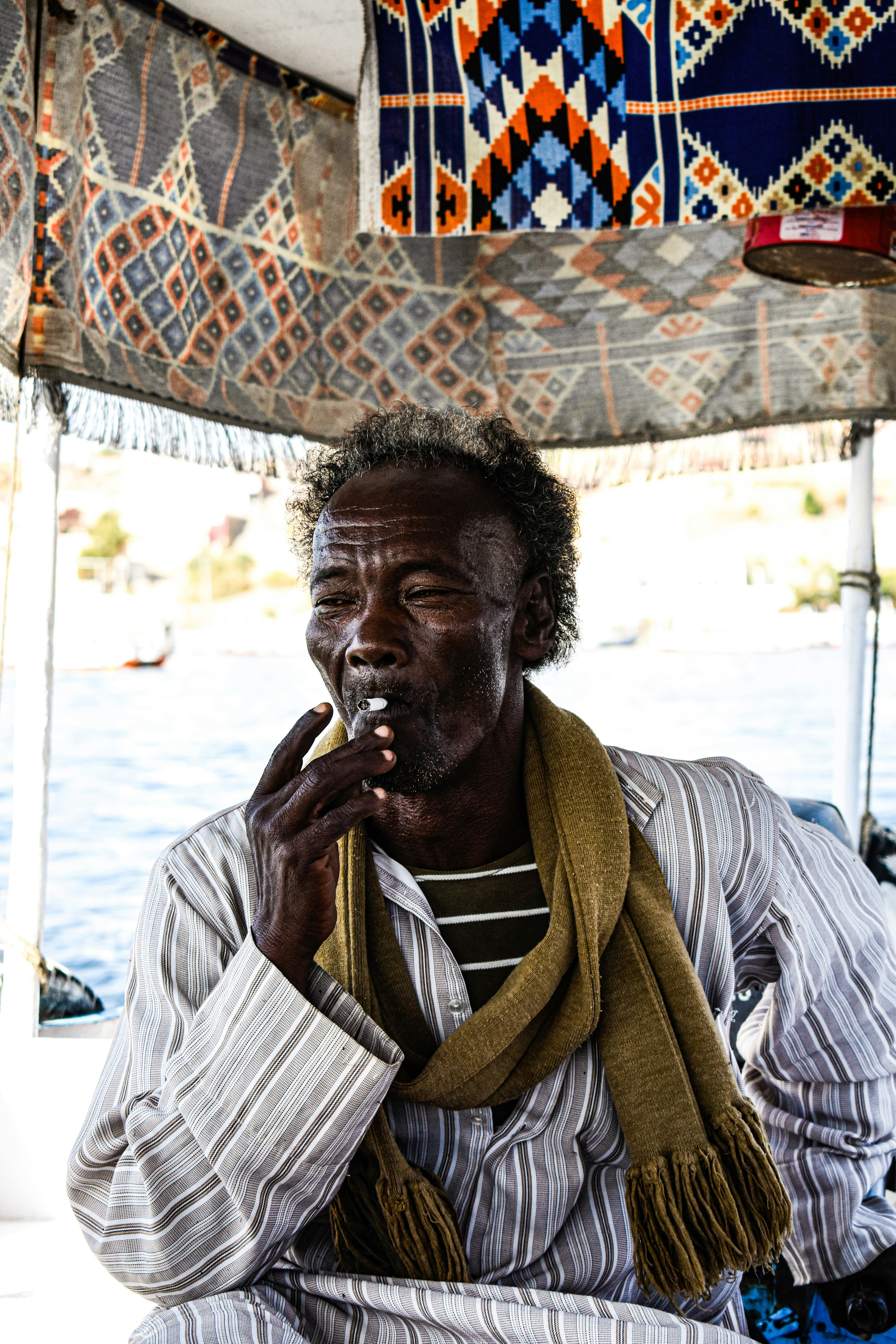 Smoker’s Pause on a Riverside Boat