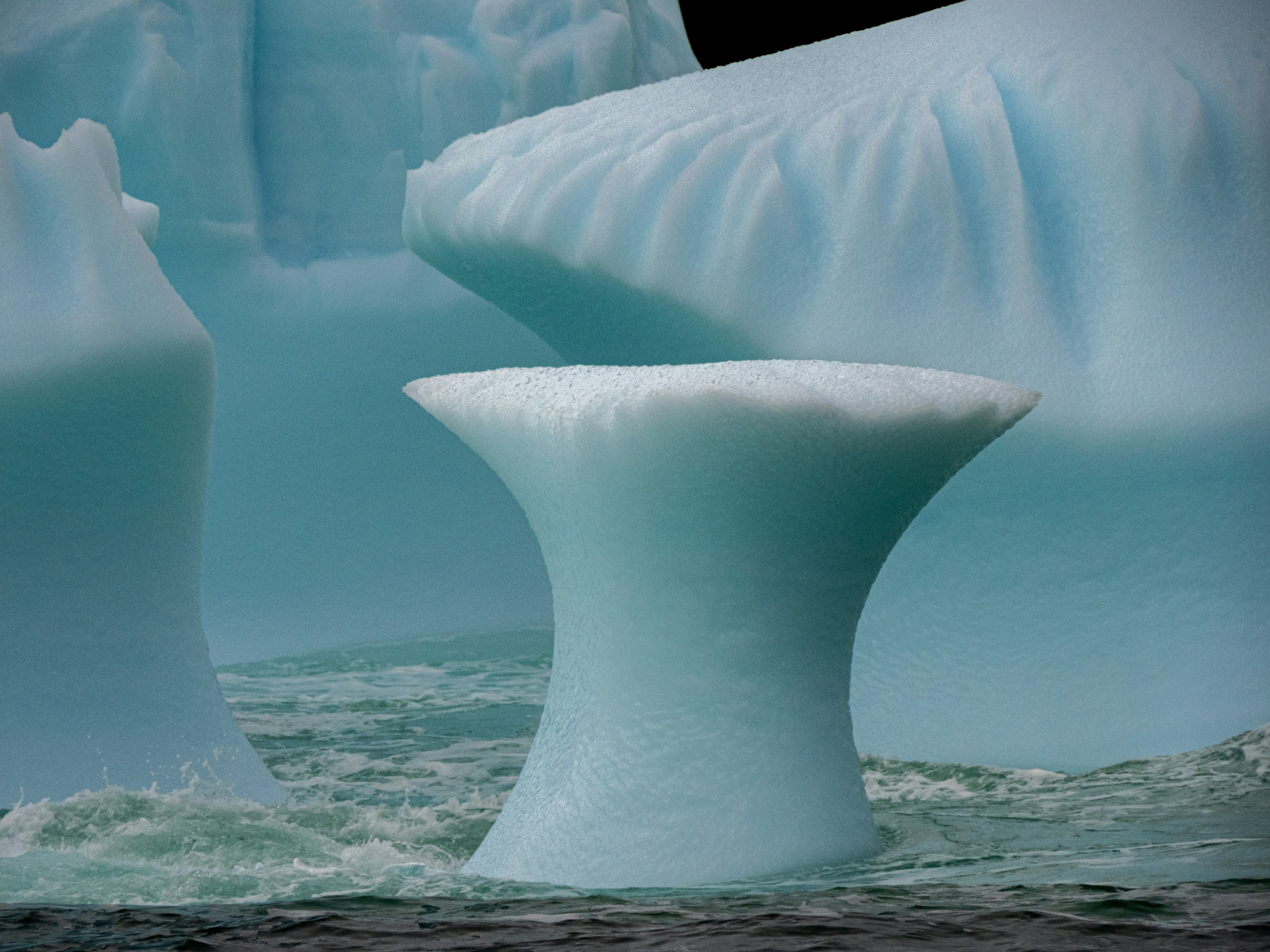 Ice Sculpture: A Tidal Hourglass Amid Arctic Blues