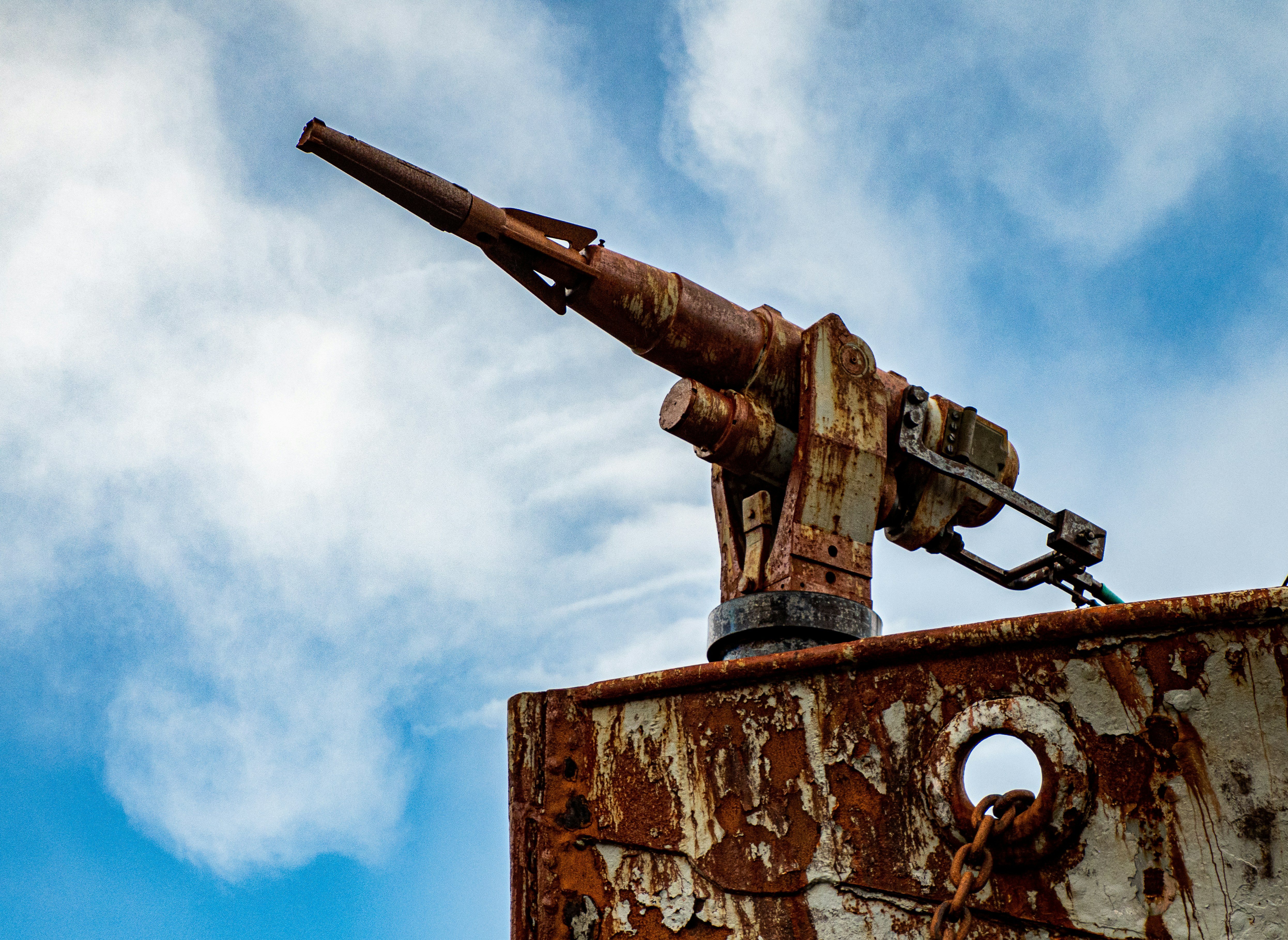 A rusted metal object with a gun on top of it photo – Free Turret Image ...