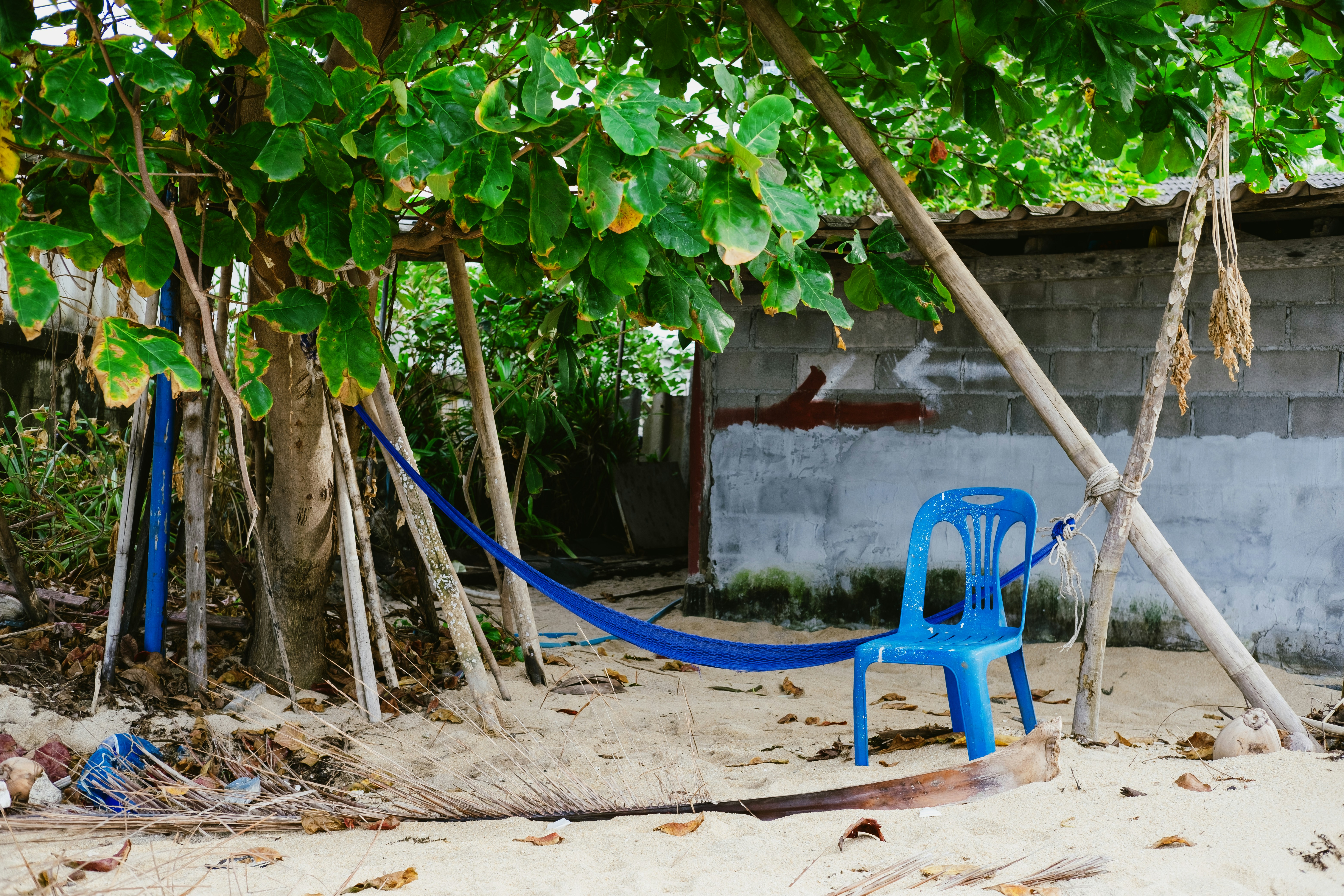 a blue chair sitting on top of a sandy beach