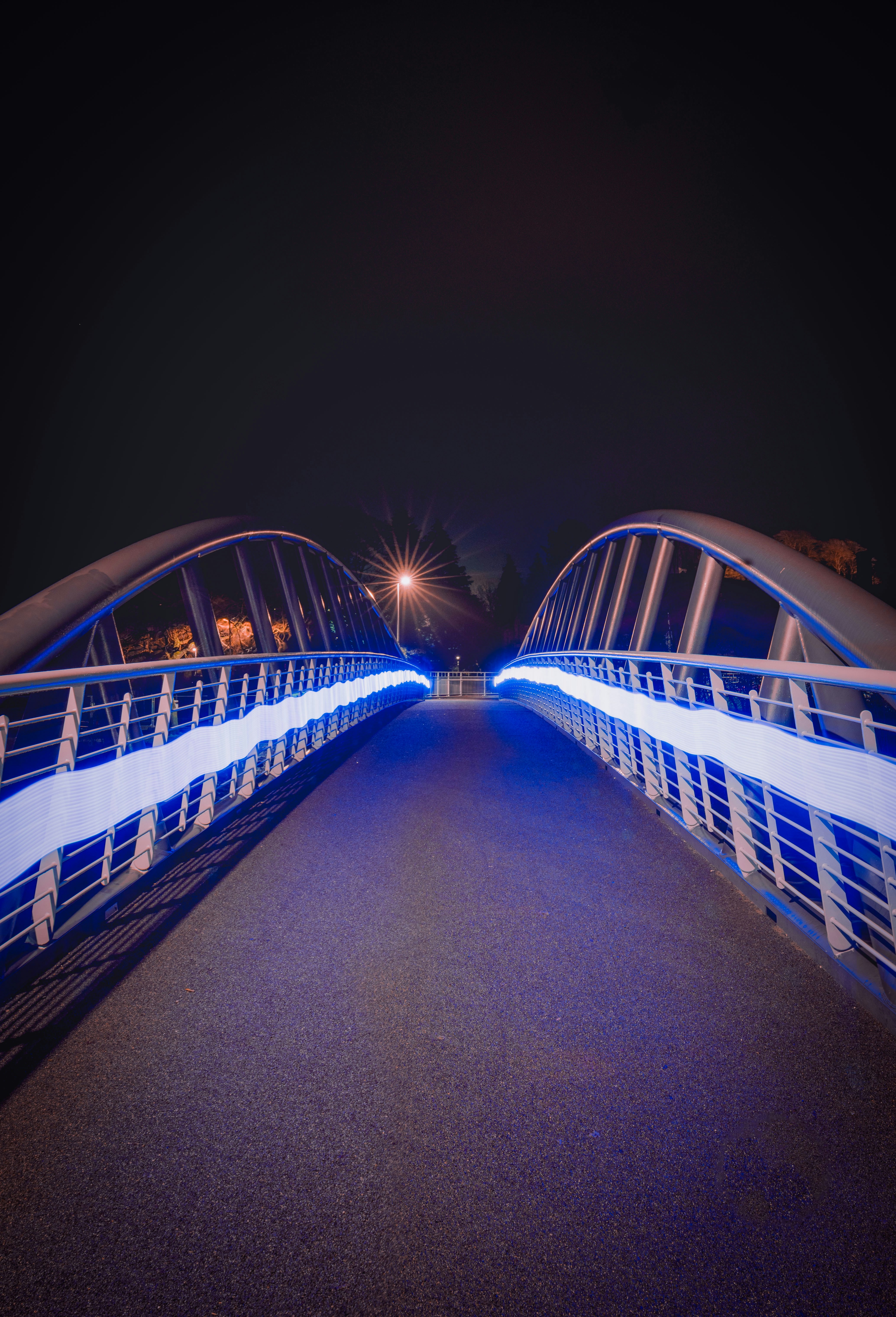 A bridge that is lit up at night photo – Free Blue Image on Unsplash