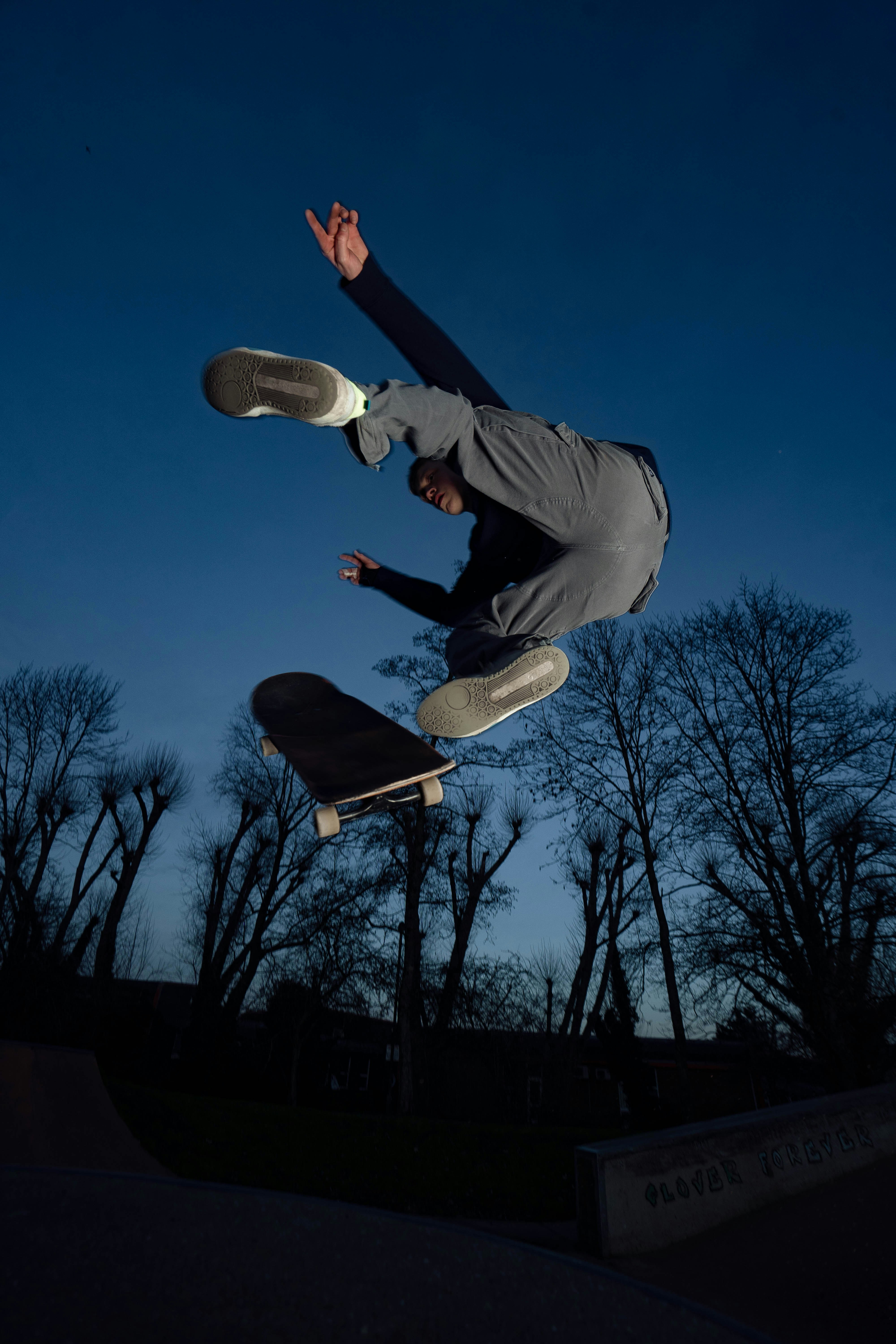 Aerial flight: skate complete with night-blue sky