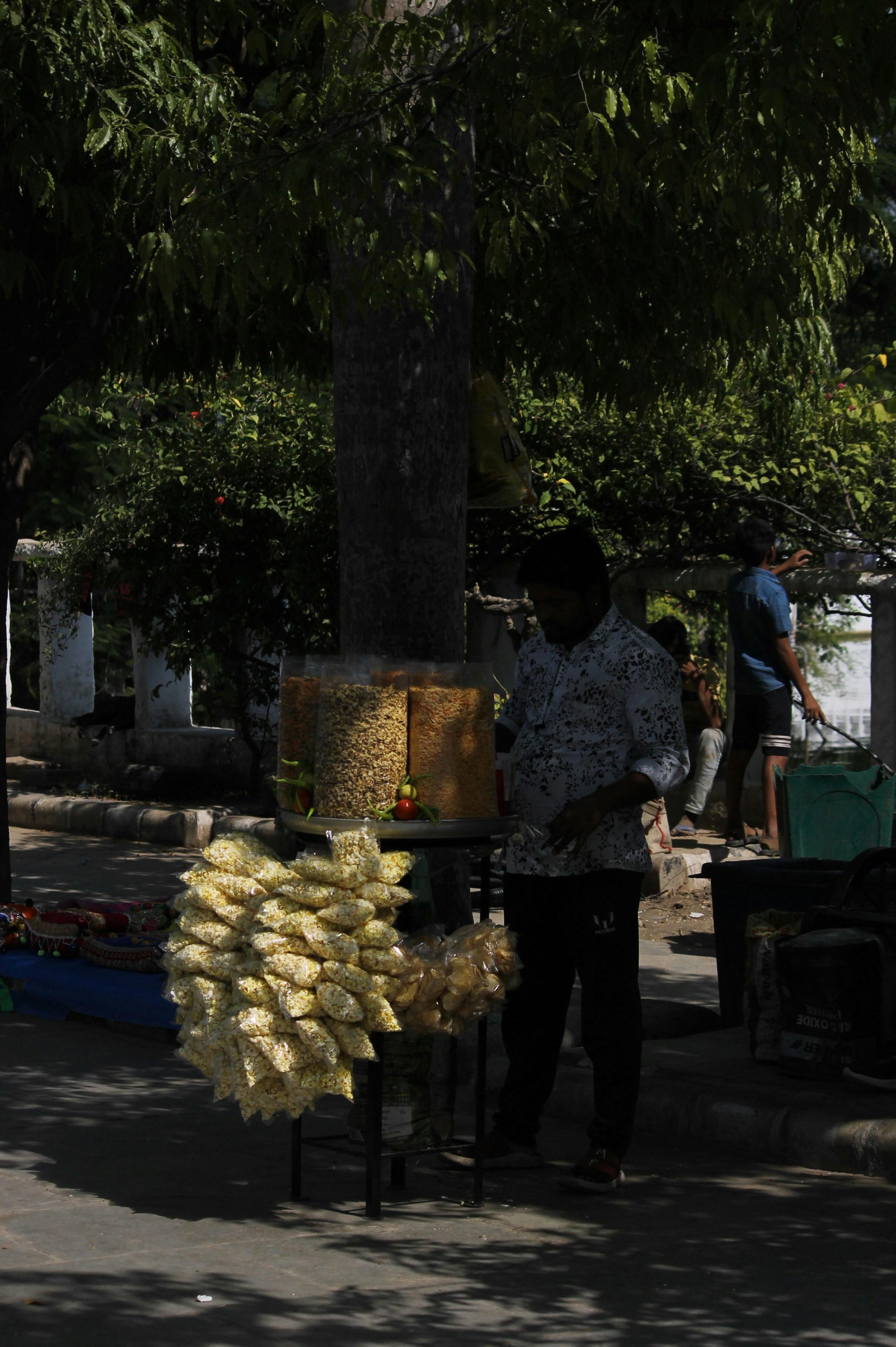 Under the Shade: Golden Snack Strands at a Street Vendor