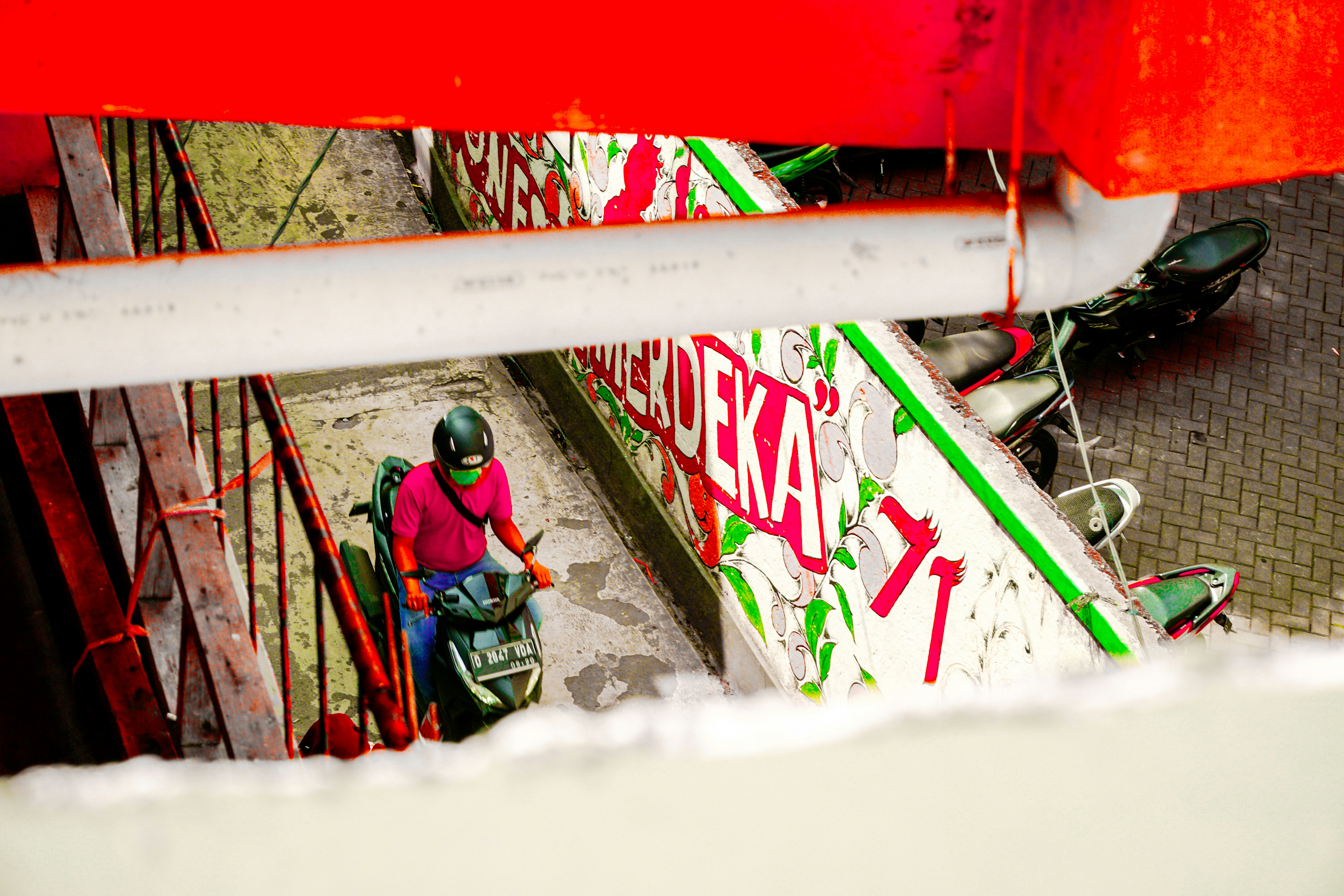 Overhead Neon Ride: A Scooter Through Graffiti Alley