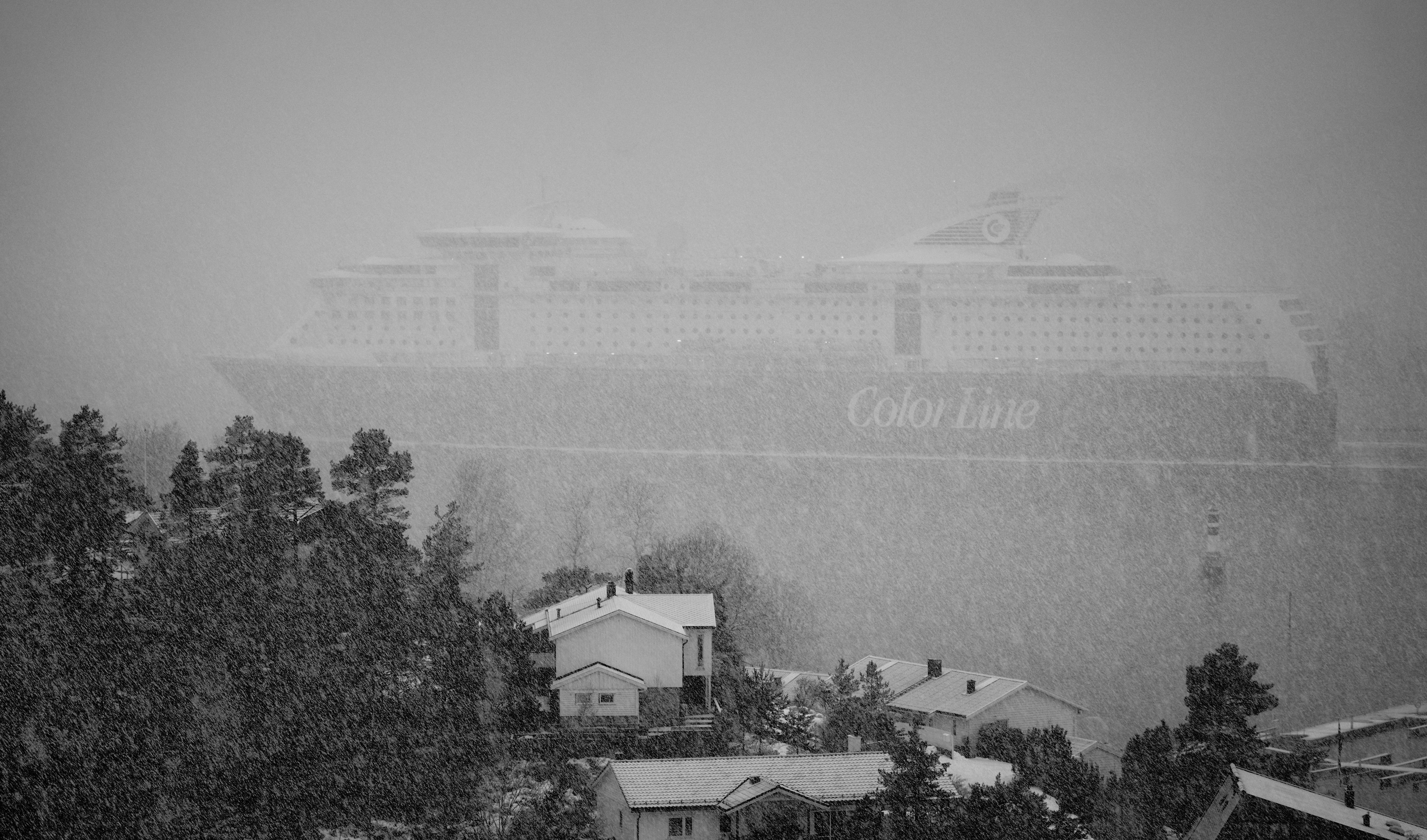 Ghostliner Over Snow: A Distant Cruise Ship Looms Above a Quiet Village