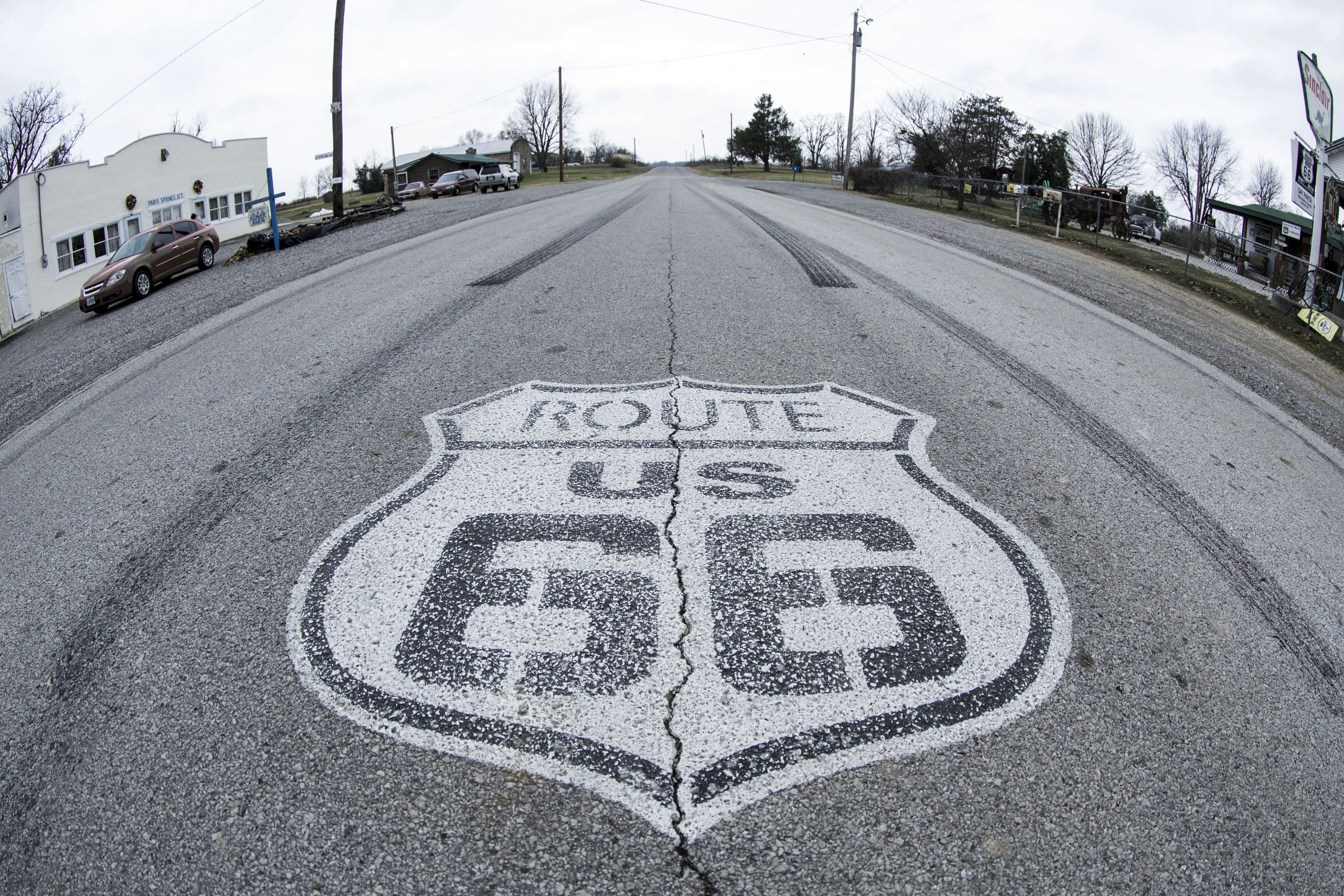 Cracked Route 66 Shield: A Wide-Angle Portrait of an Empty Highway