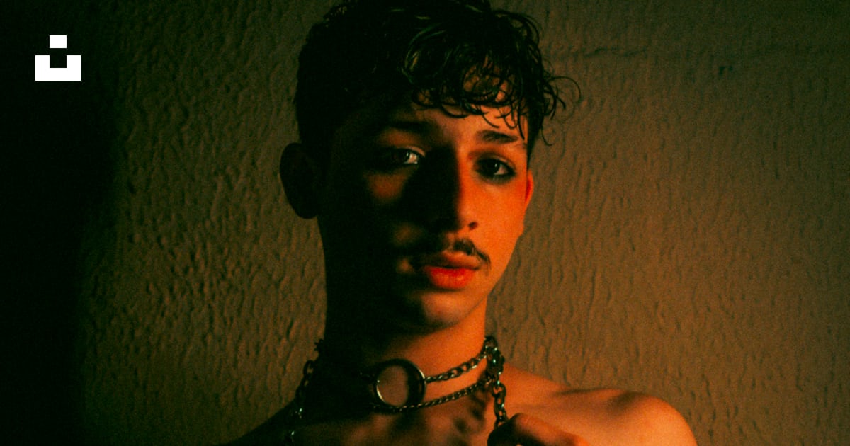 A Shirtless Man With A Necklace Around His Neck Photo Free Portrait